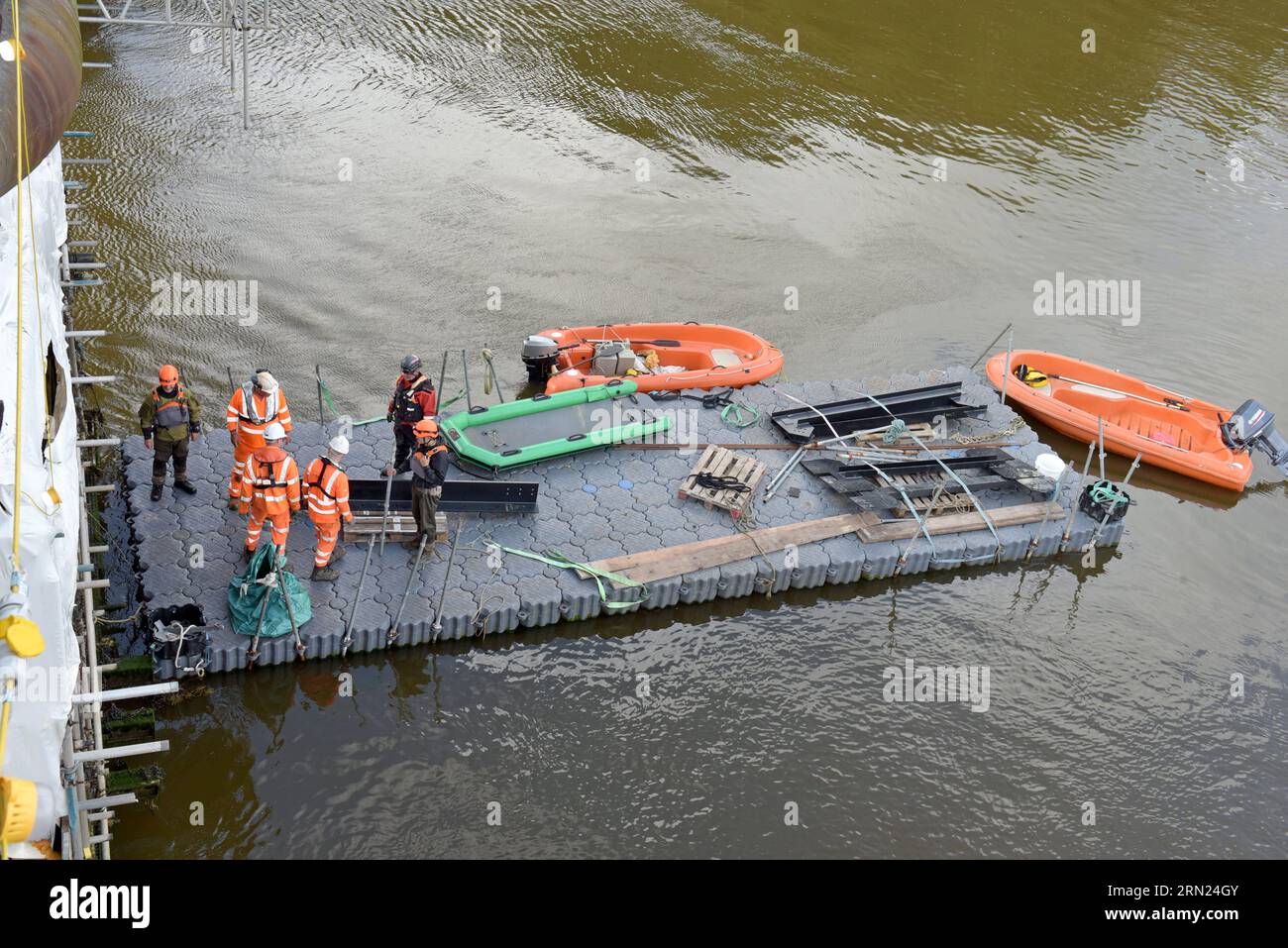 Railway engineers on pontoons moving new steelwork into place for the ...