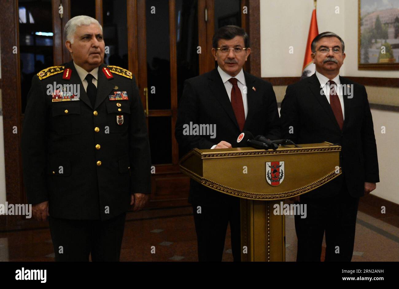 Turkish Prime Minister Ahmet Davutoglu(C) speaks about the military ...