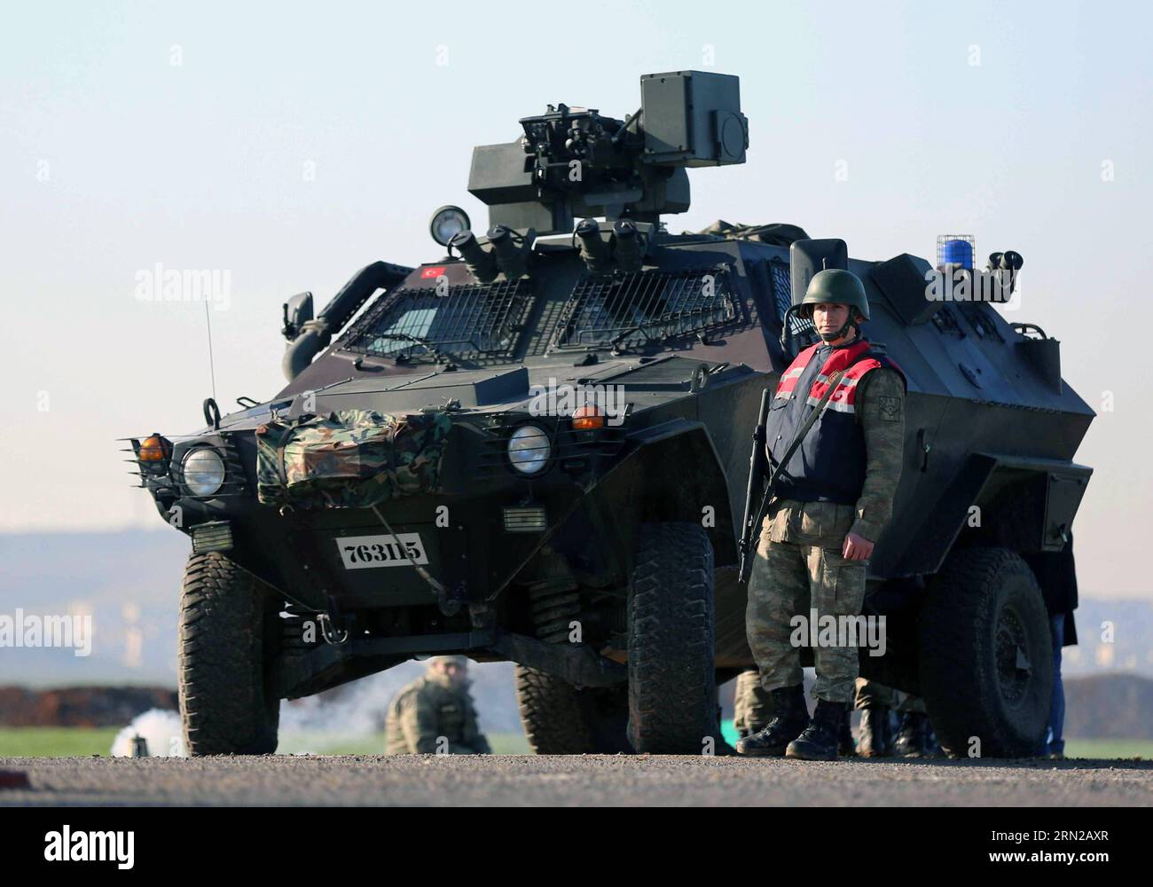 A Turkish soldier stands guard beside an armored vehicle during the ...