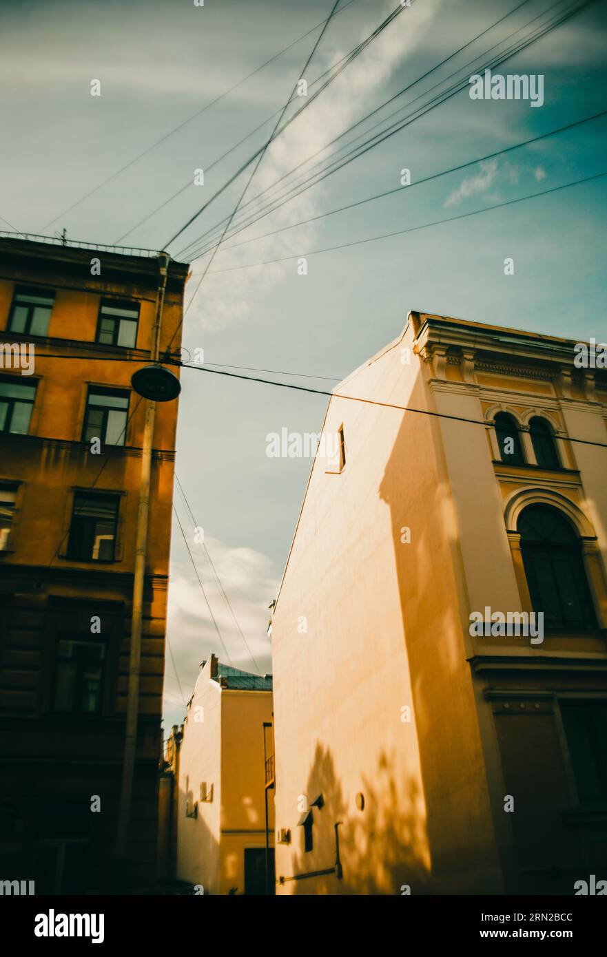 A cityscape with old yellow buildings illuminated by the morning sun ...
