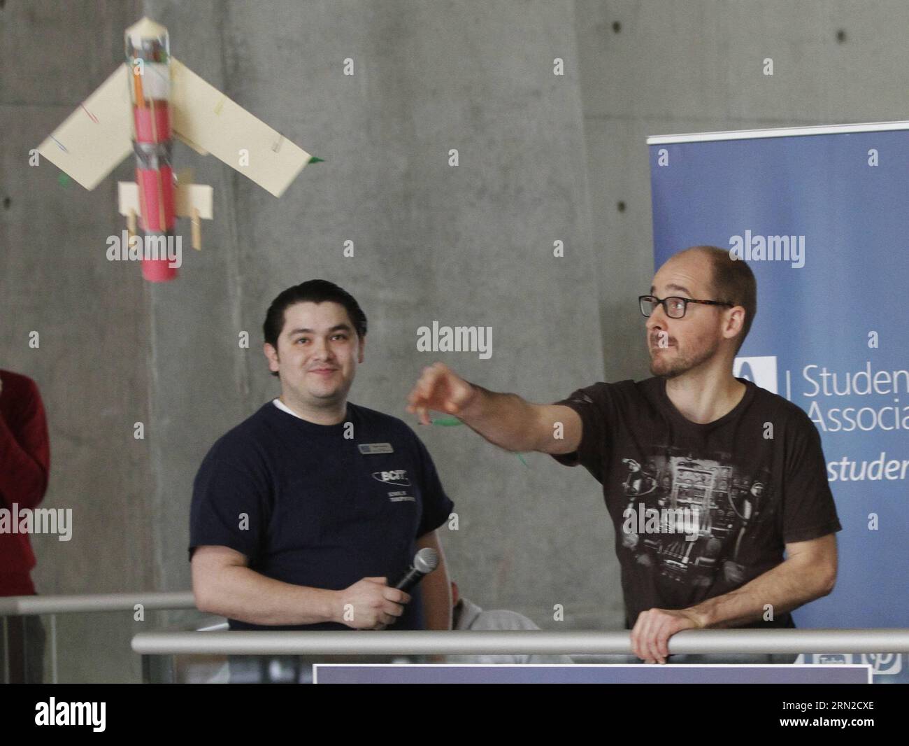An engineering student launches his paper plane during the flying ...