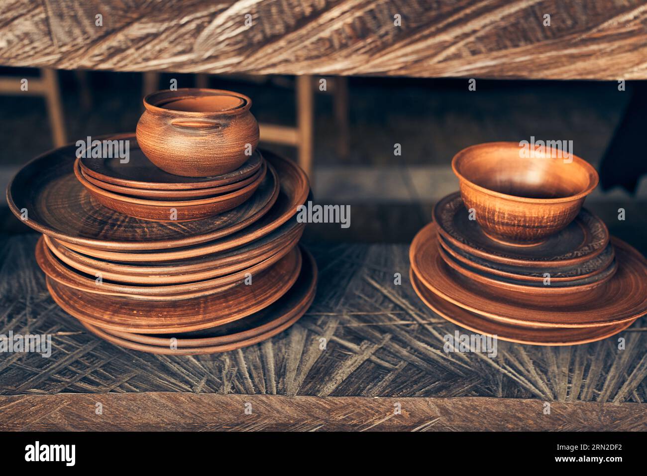 A stack of clay plates of different sizes on a dark background. Level ...