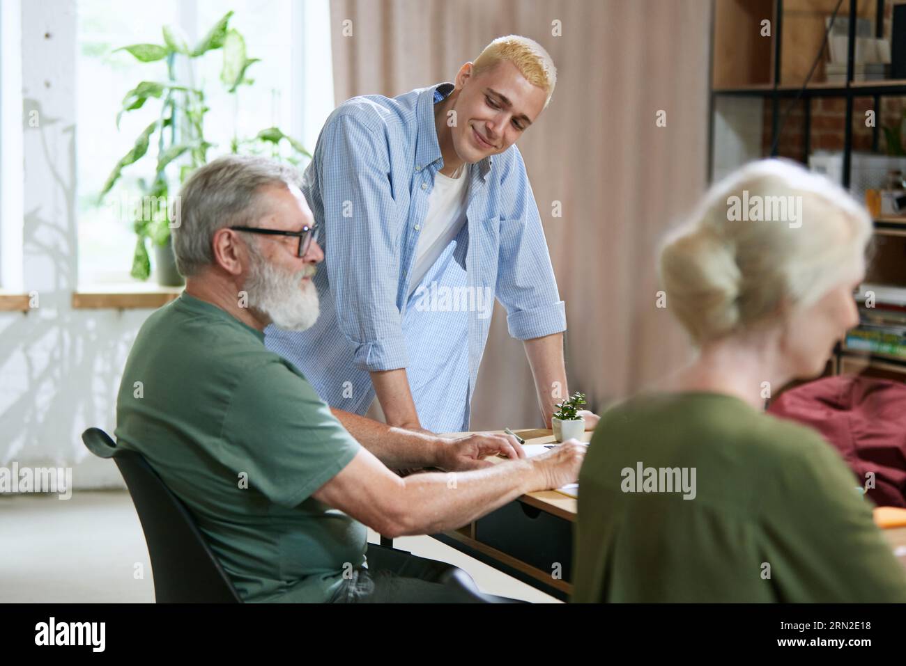 Professional cooperation among employees. Young man and senior business ...