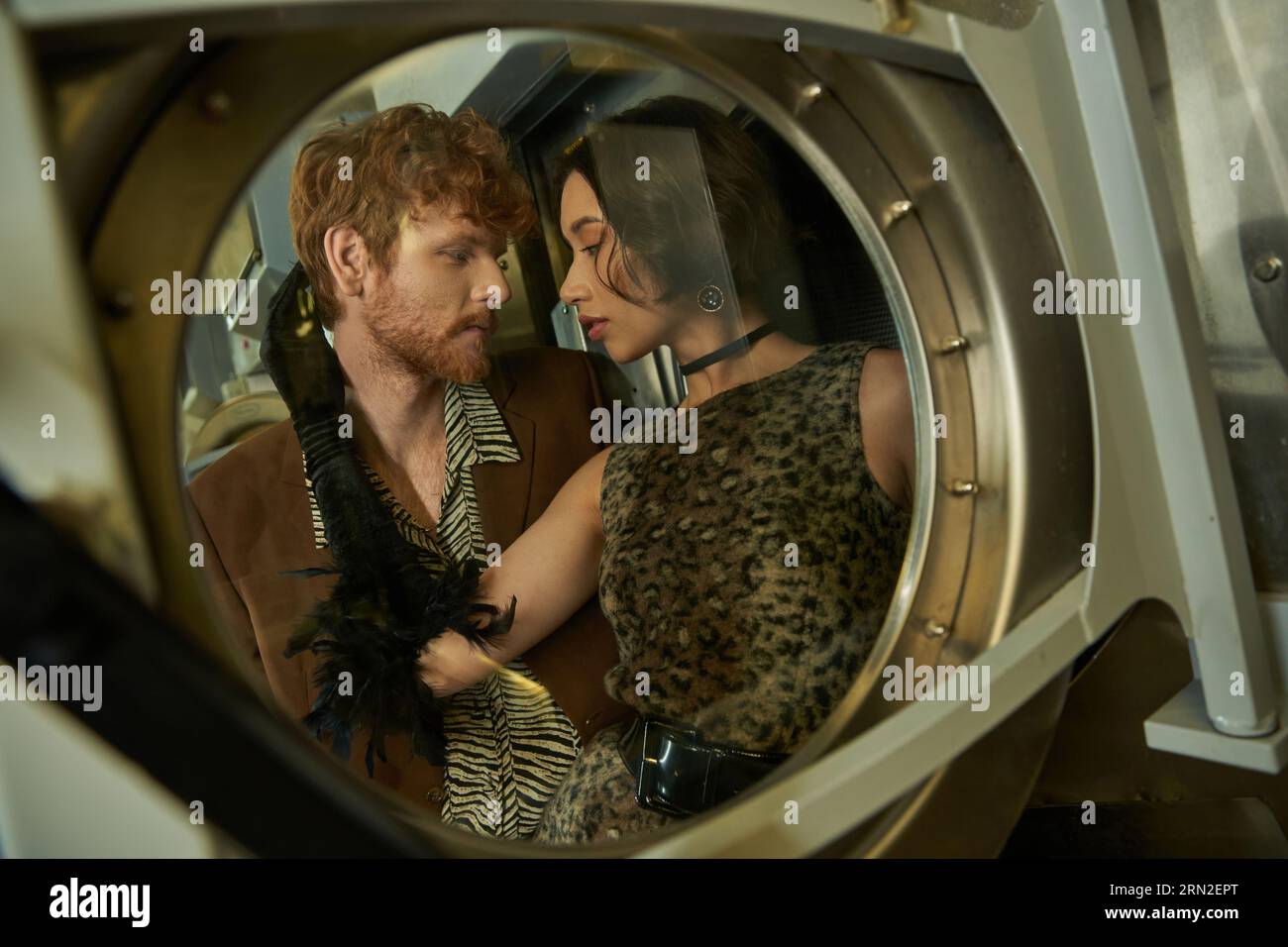 stylish young asian woman touching boyfriend behind washing machine in ...