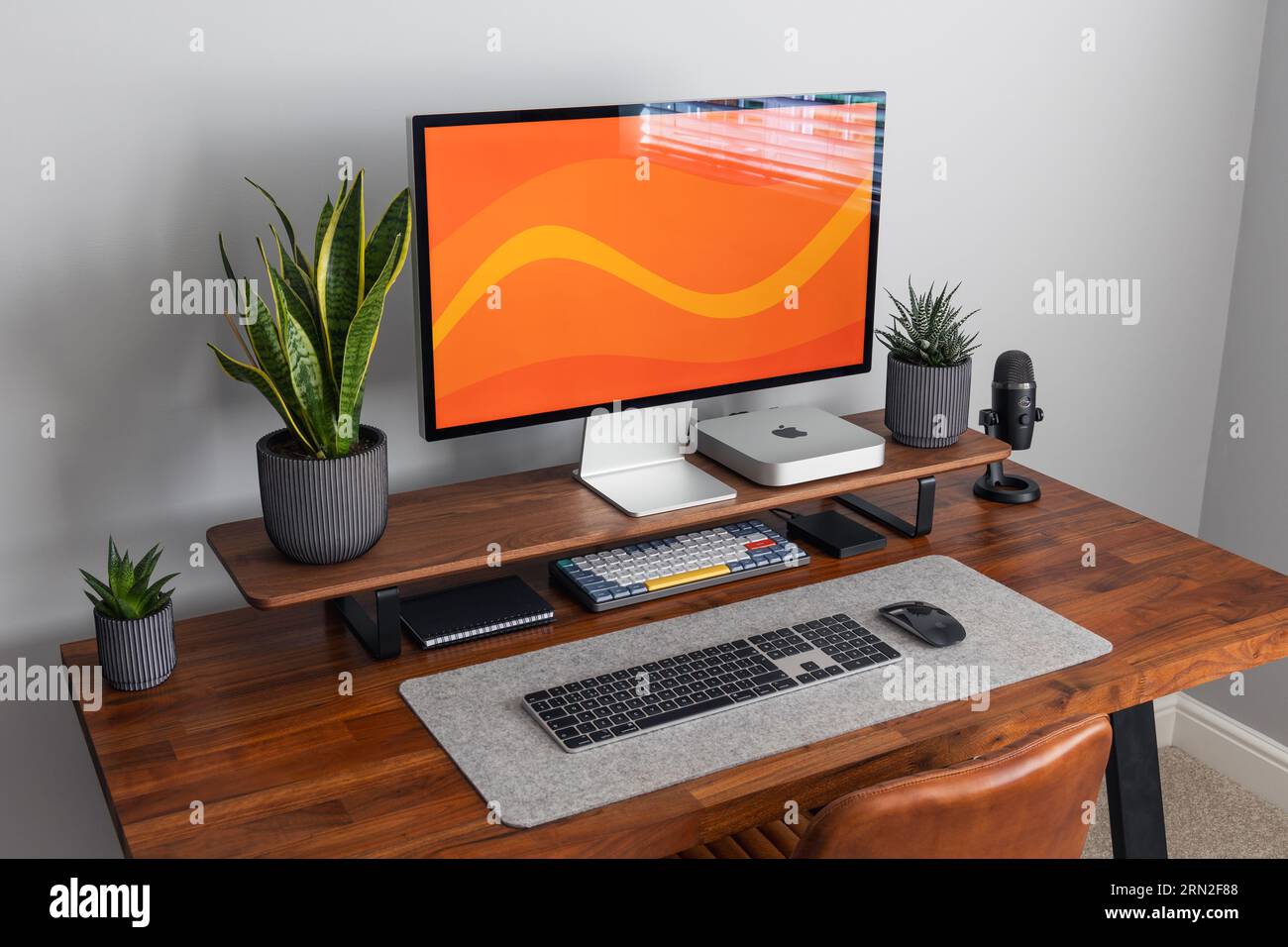 LONDON - AUGUST 24, 2023: Apple Studio Display and Mac Mini computer in ...