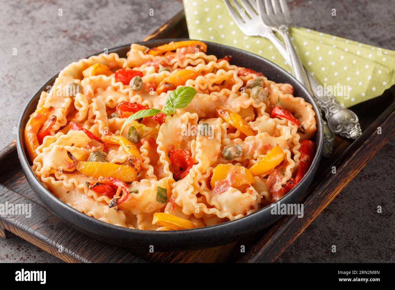 Ribbon-shaped Italian pasta mafaldine cooked with creamy tomato sauce ...