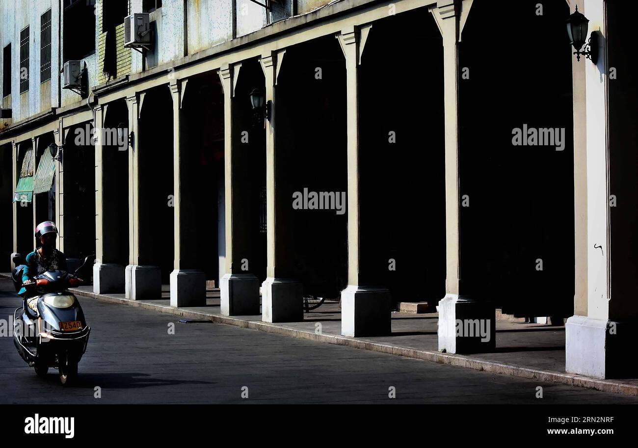 A resident rides past a Qilou building in Chaozhou City, south China s ...