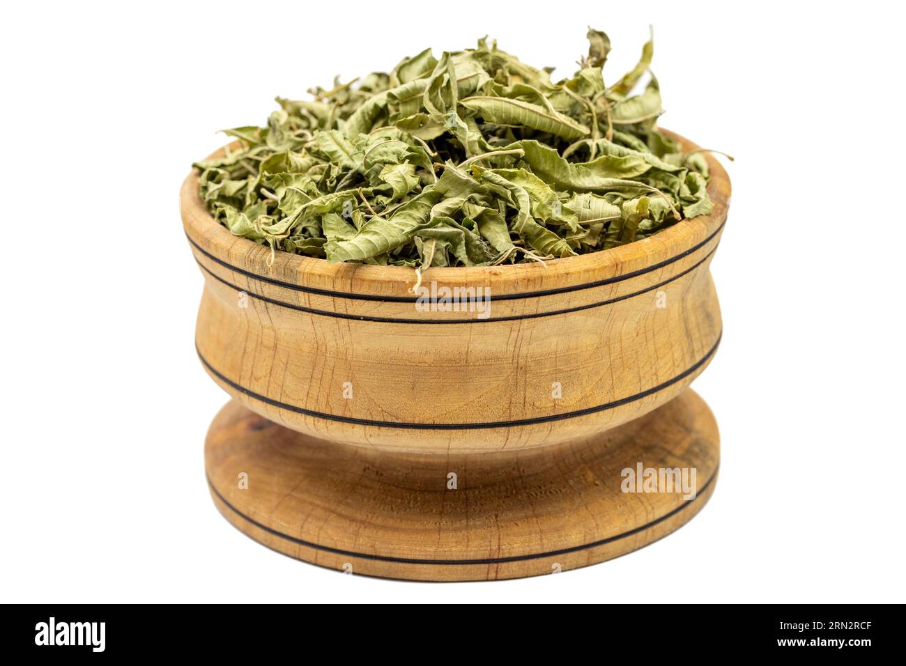 Melissa tea leaves. Sun-dried lemon balm tea leaves in wood bowl ...
