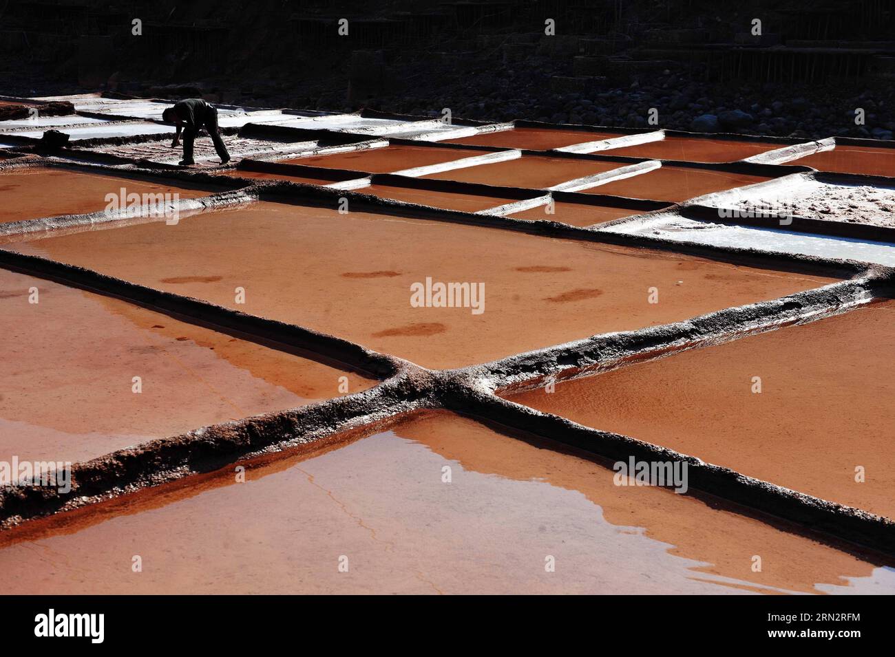 A villager works on salt pans in Markam County, southwest China s Tibet ...