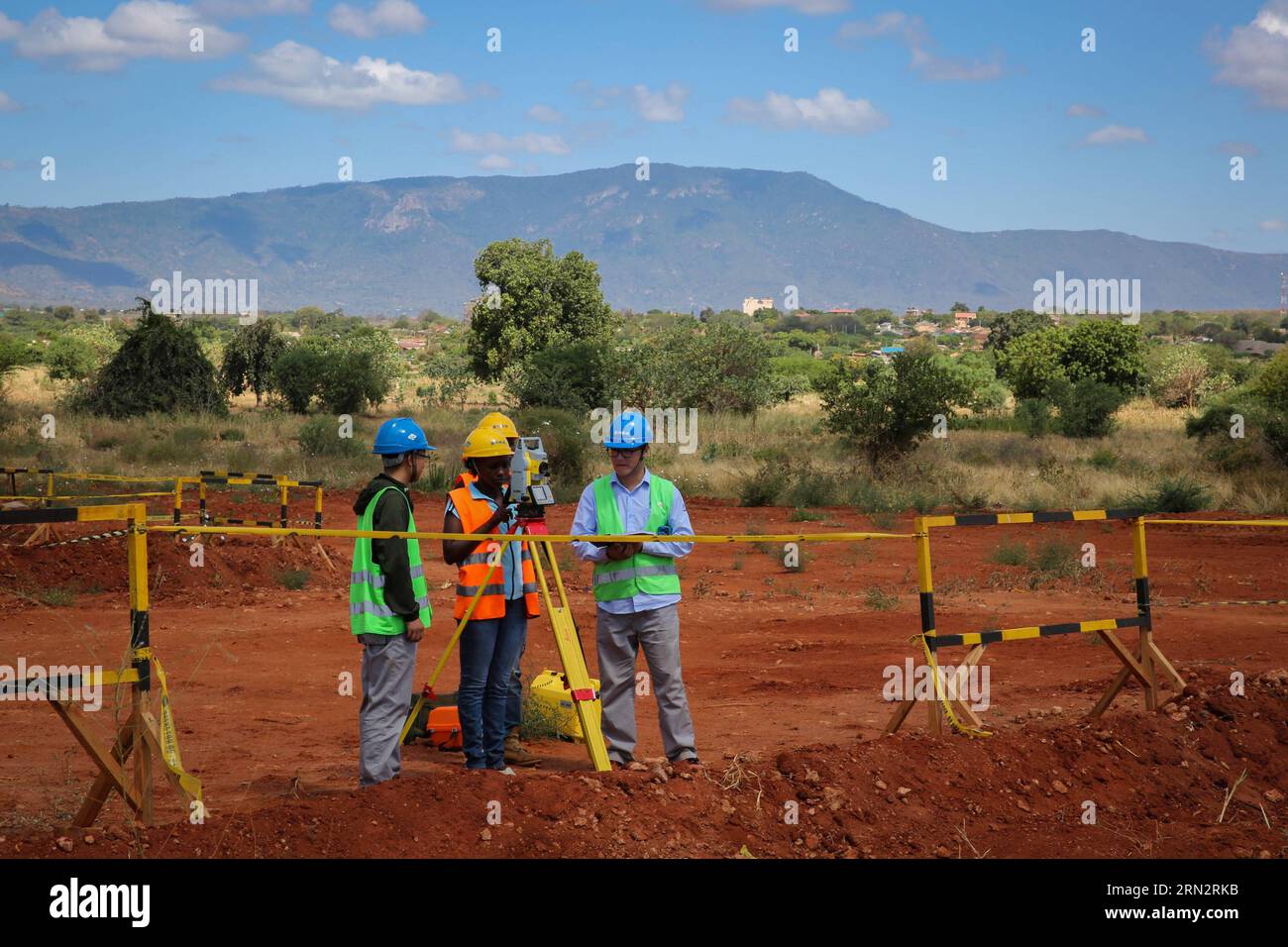 Chinese engineers work with their Kenyan colleagues at a construction ...