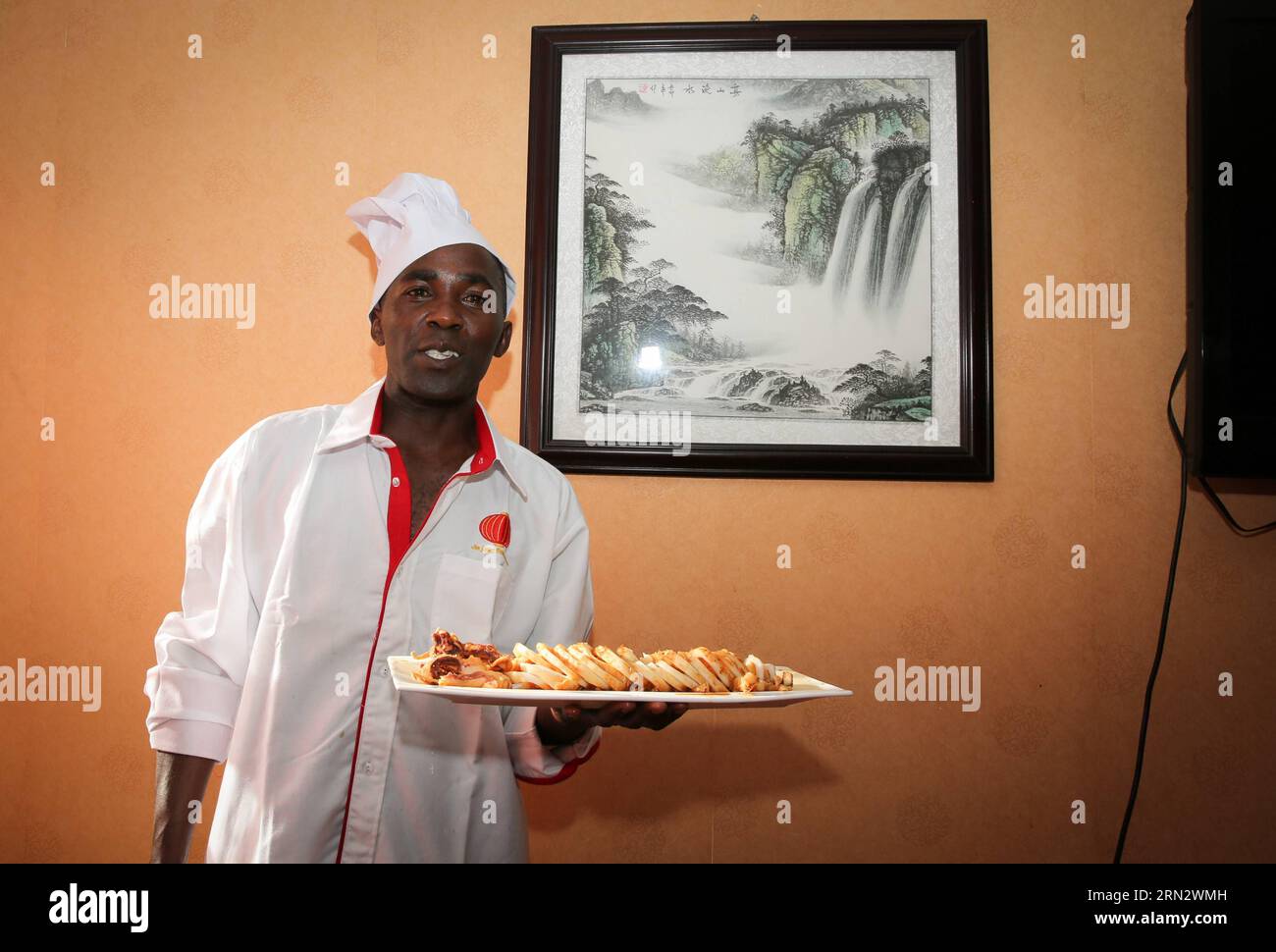 Chef Reagan Mdogo Amalemba shows a Chinese cuisine cooked by himself at ...