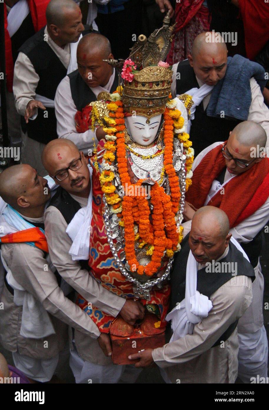 People carry an idol of Seto Machhendranath from a temple to a chariot ...
