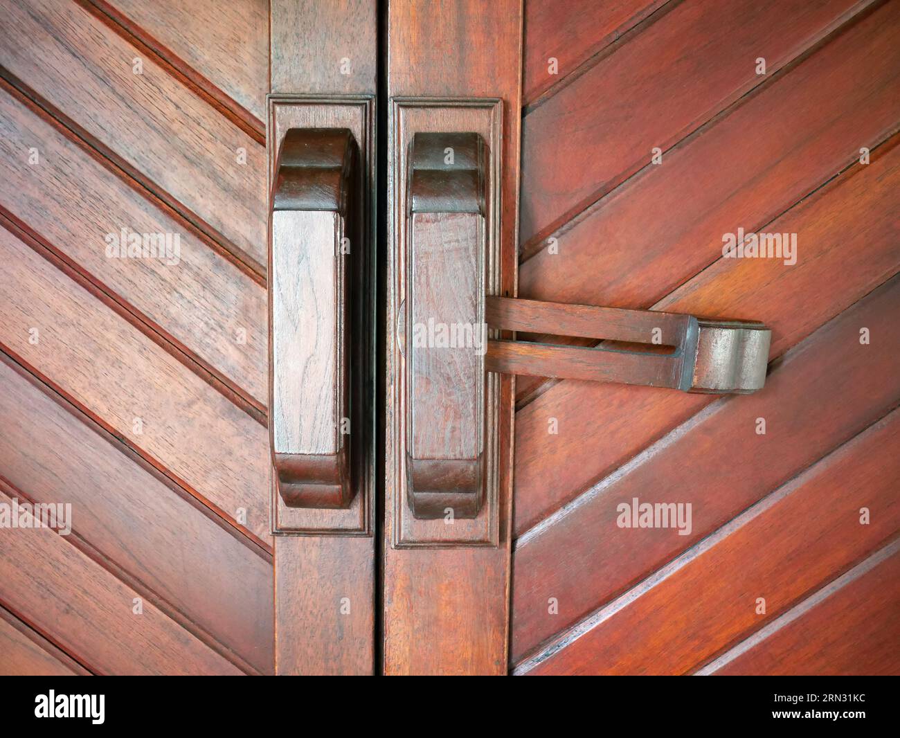 Close up antique wooden door latch lock on the vintage ornate wooden ...