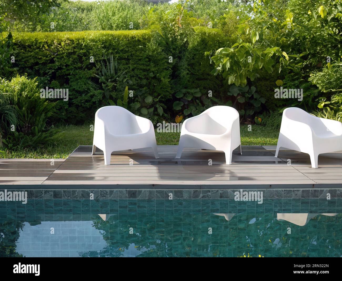 Modern design white plastic chairs at swimming pool side and outdoor ...