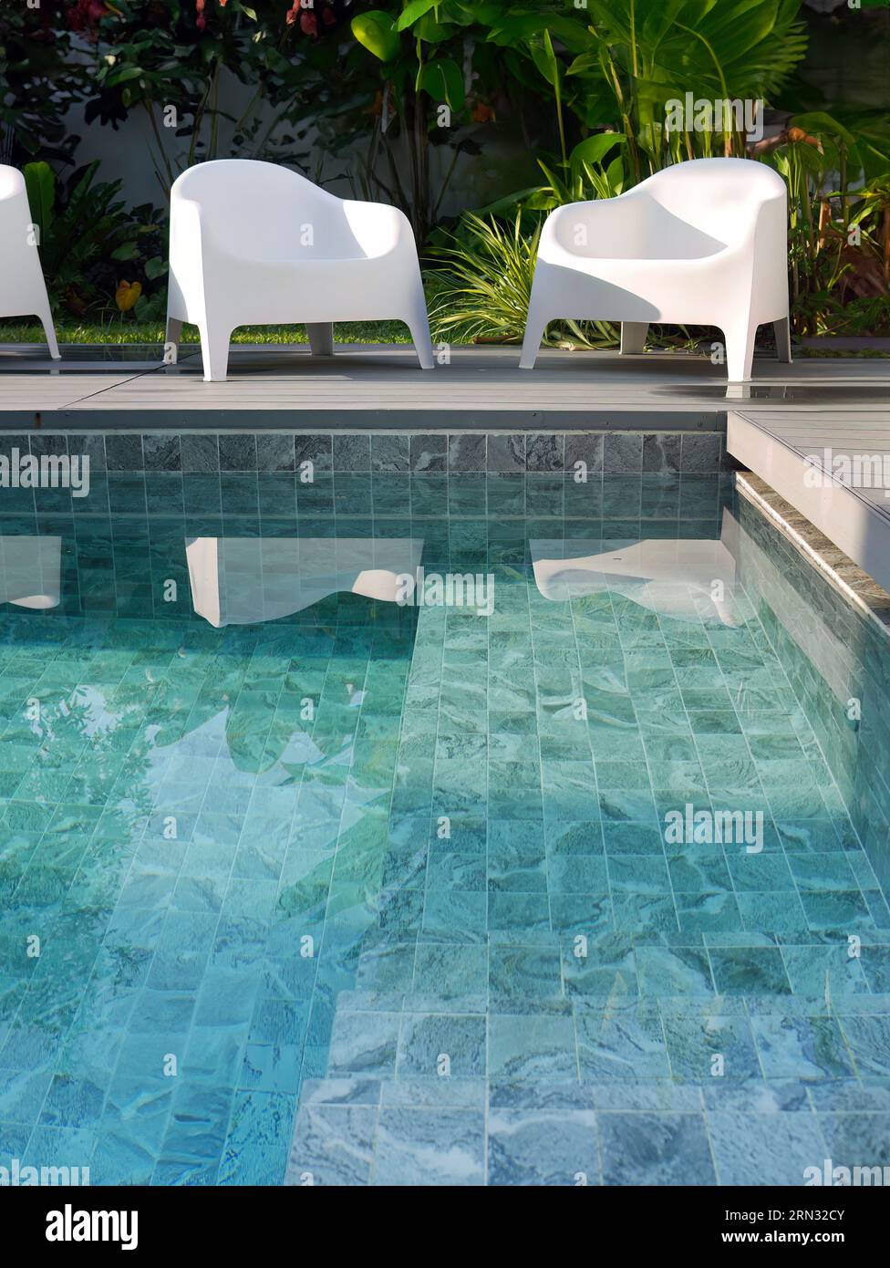 Modern design white plastic chairs at swimming pool side and outdoor ...
