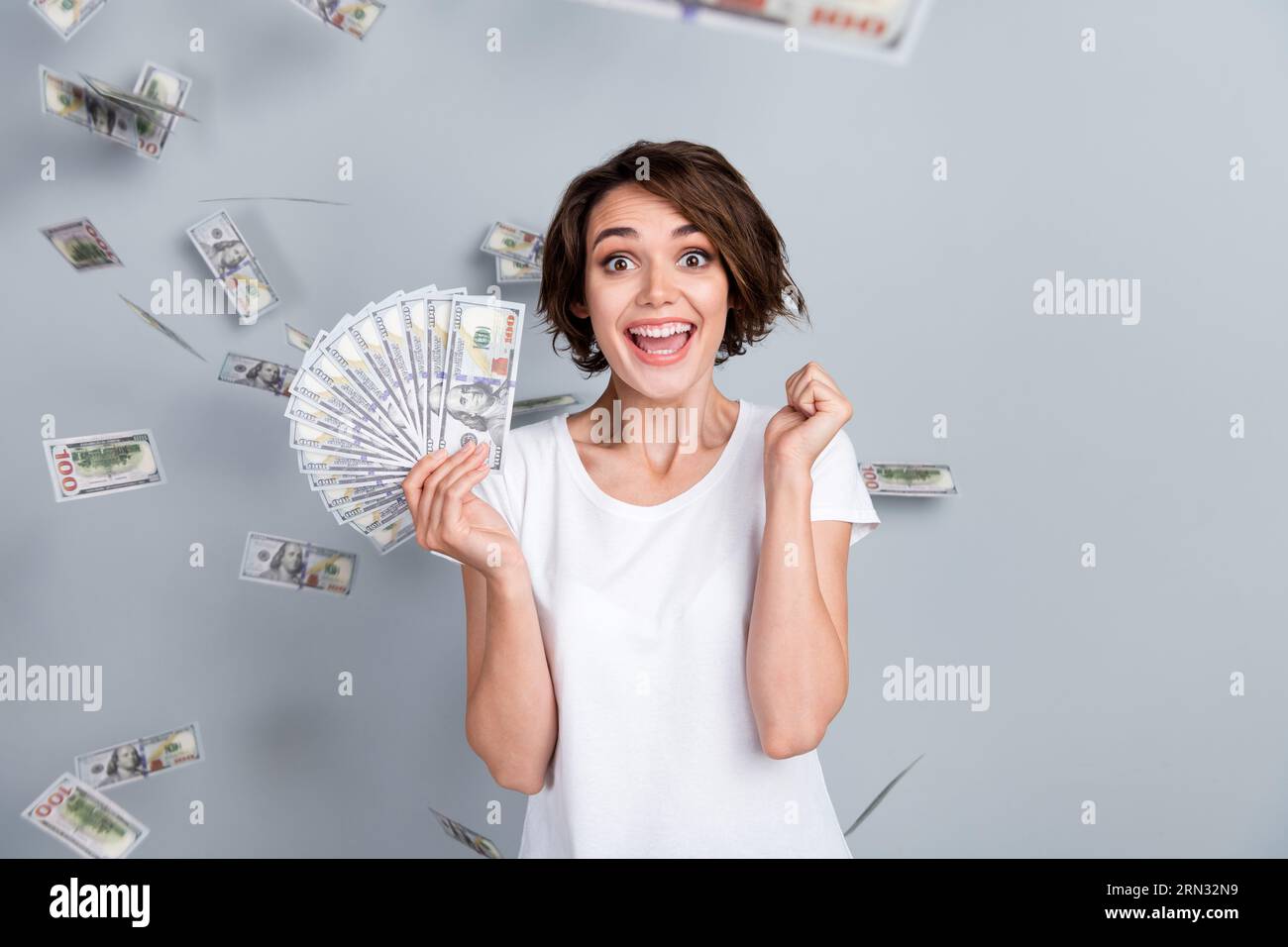 Photo of excited lucky lady wear white t-shirt rising fist winning ...