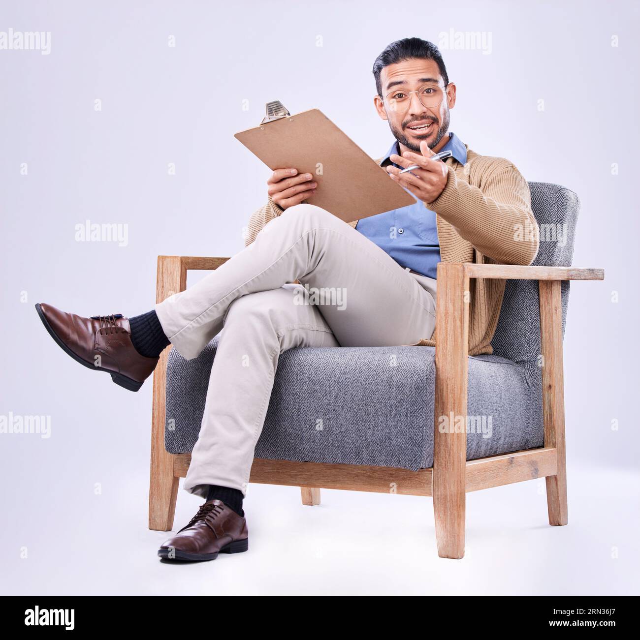 Portrait, question and a man psychologist in a chair on a white ...