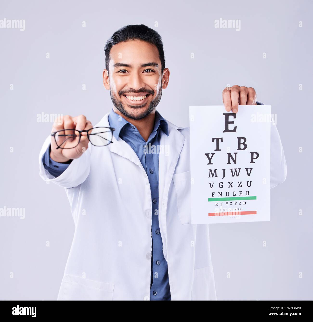 Man, glasses and eye chart of optometrist in portrait at studio ...
