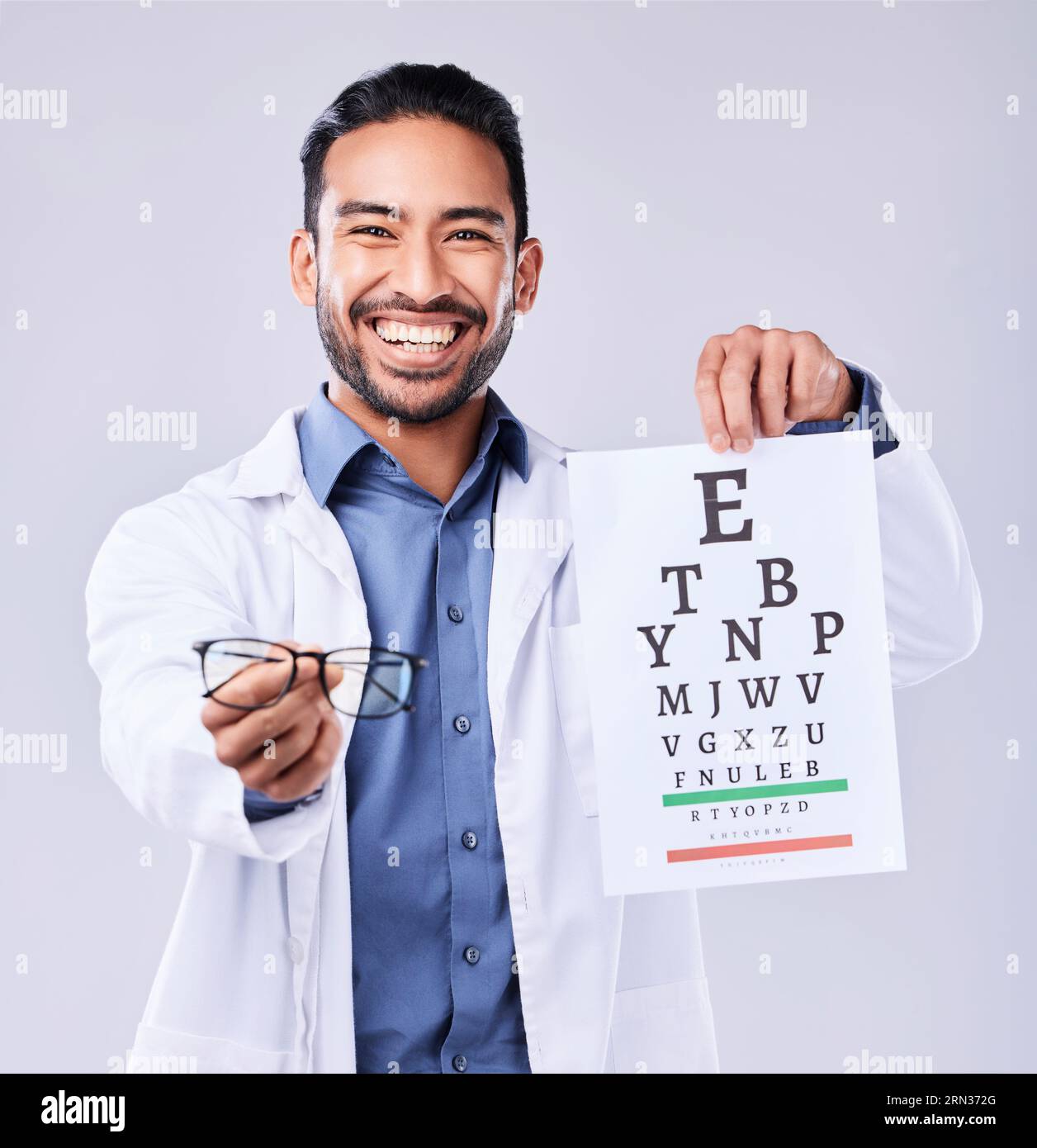 Man, glasses and eye chart of ophthalmologist in portrait at studio ...