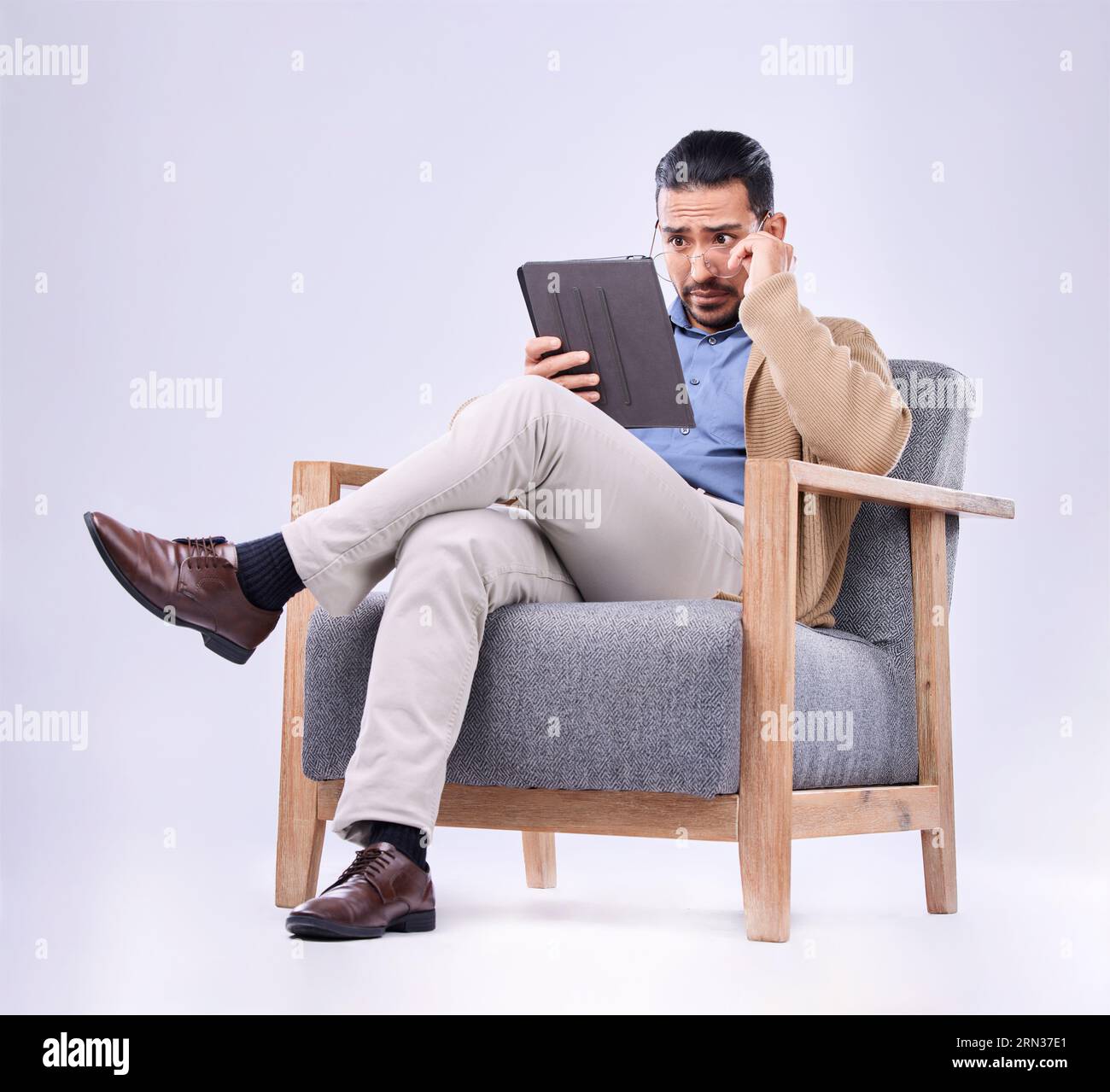 Tablet, concern and a man psychologist in a chair on a white background ...