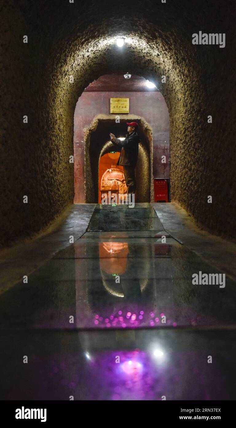 TURPAN, 2015 -- A tourist watches a karez well in a karez well museum ...