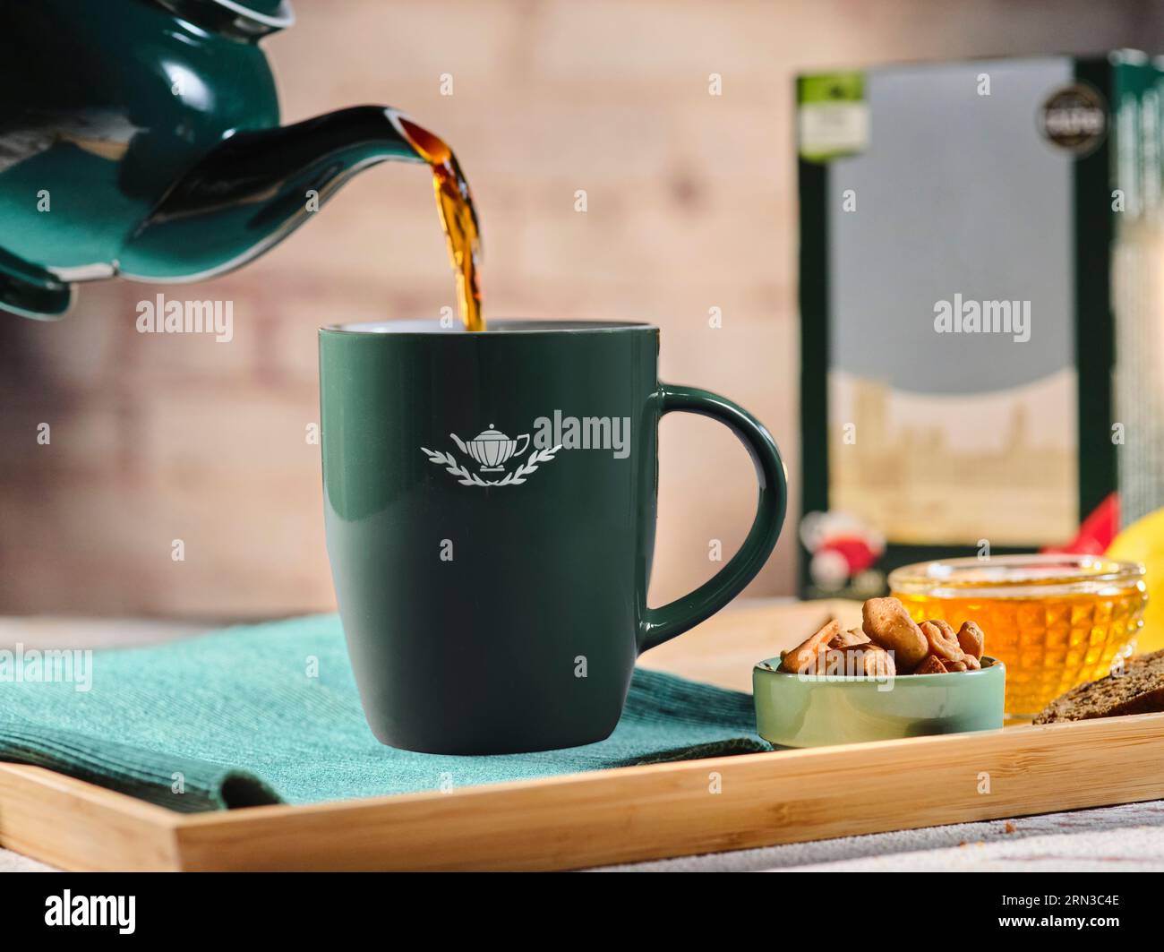 tea photoshoot with tea pot and honey in the background. tea bag ...