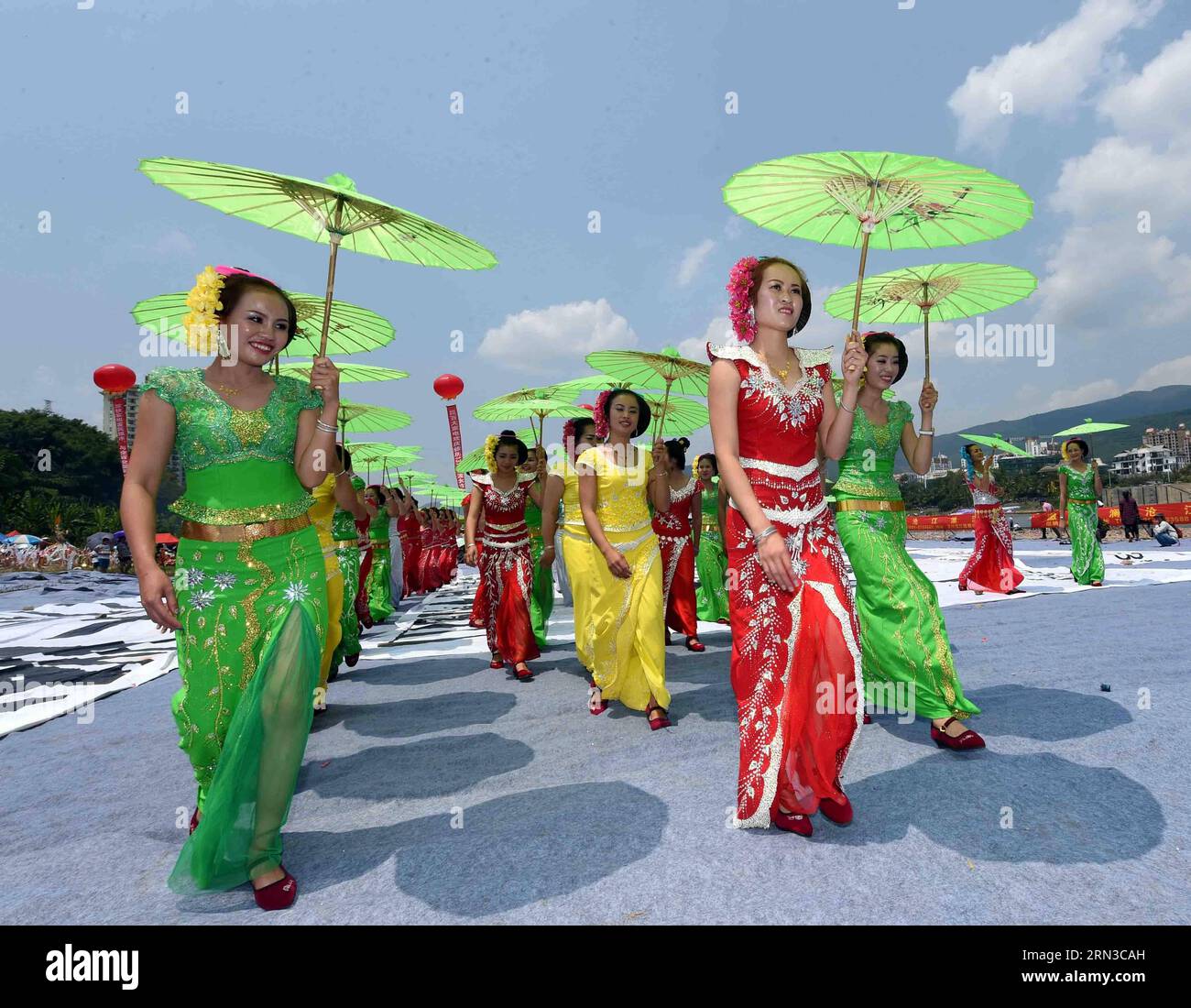 People in folk costumes perform traditional umbrella dance to celebrate ...