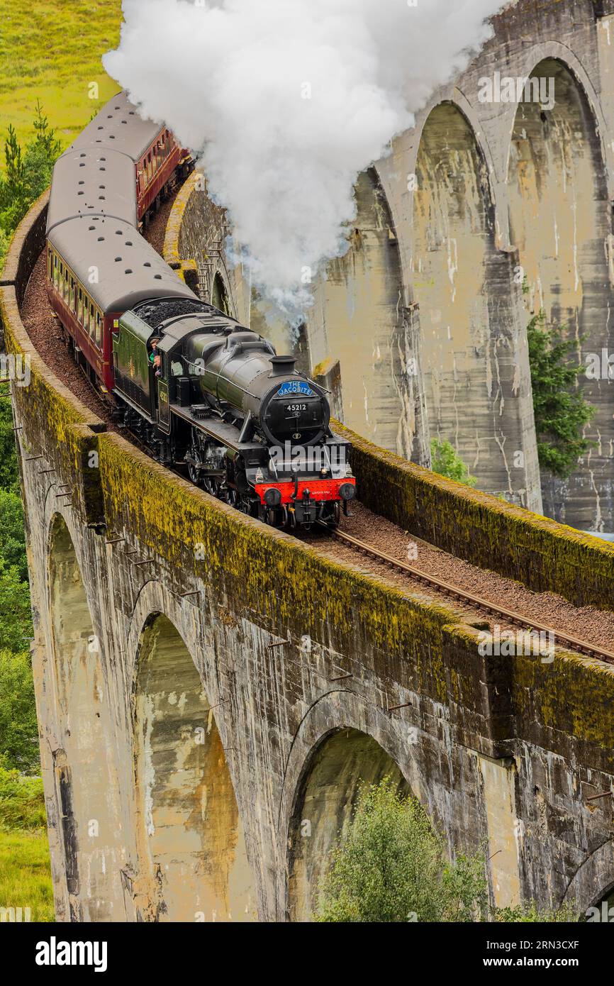 Famous steam training passing over a curved viaduct at Glenfinnan in ...