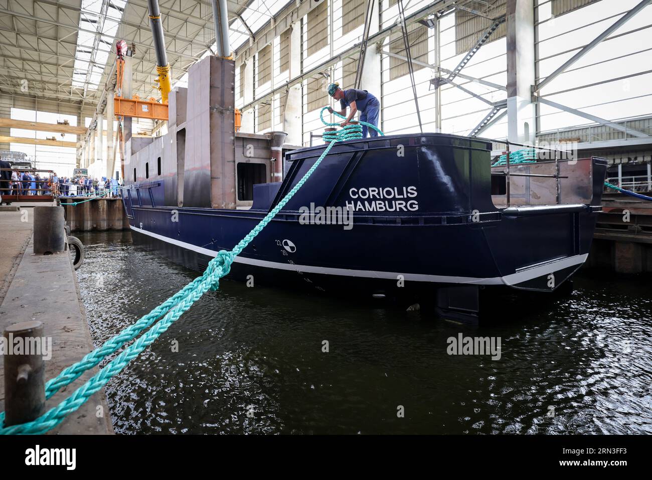Lauenburg, Germany. 31st Aug, 2023. Shipyard workers moor the shell of ...