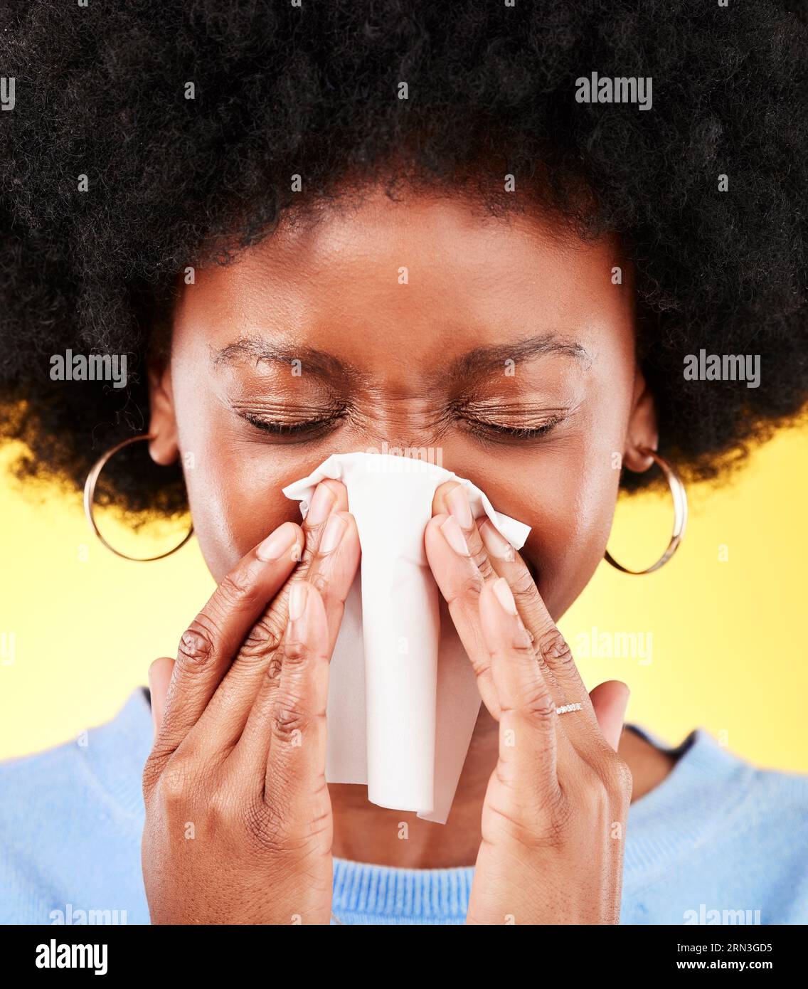 Nose, face and sneeze of sick woman in studio for cold, allergies and ...