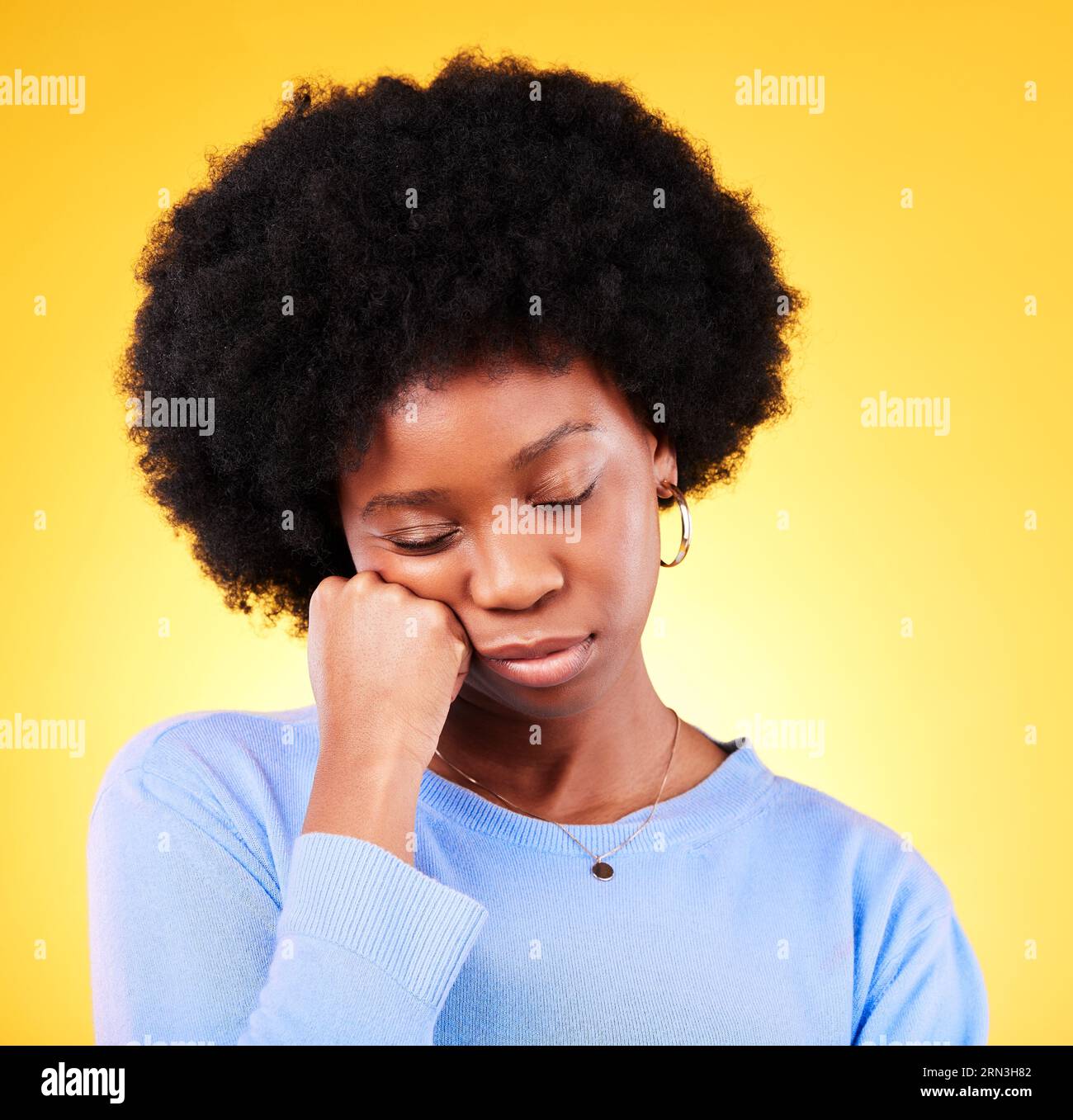 Tired, black woman and hand on face in studio looking sad, fatigue and ...