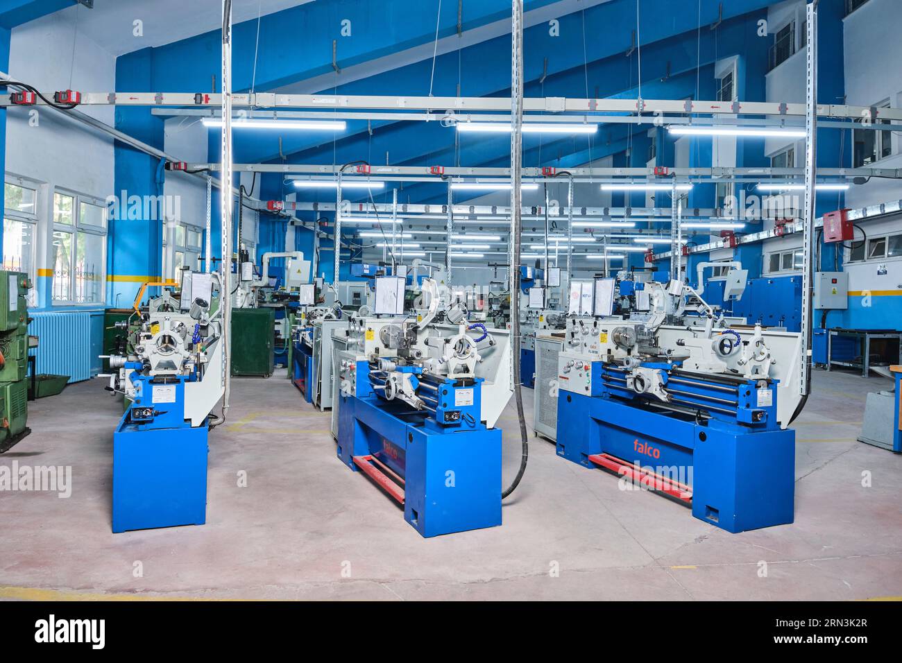 many identical industrial machinery in a row at a factory. equipment of ...