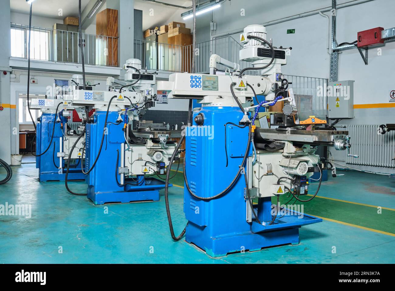 many identical industrial machinery in a row at a factory. equipment of ...