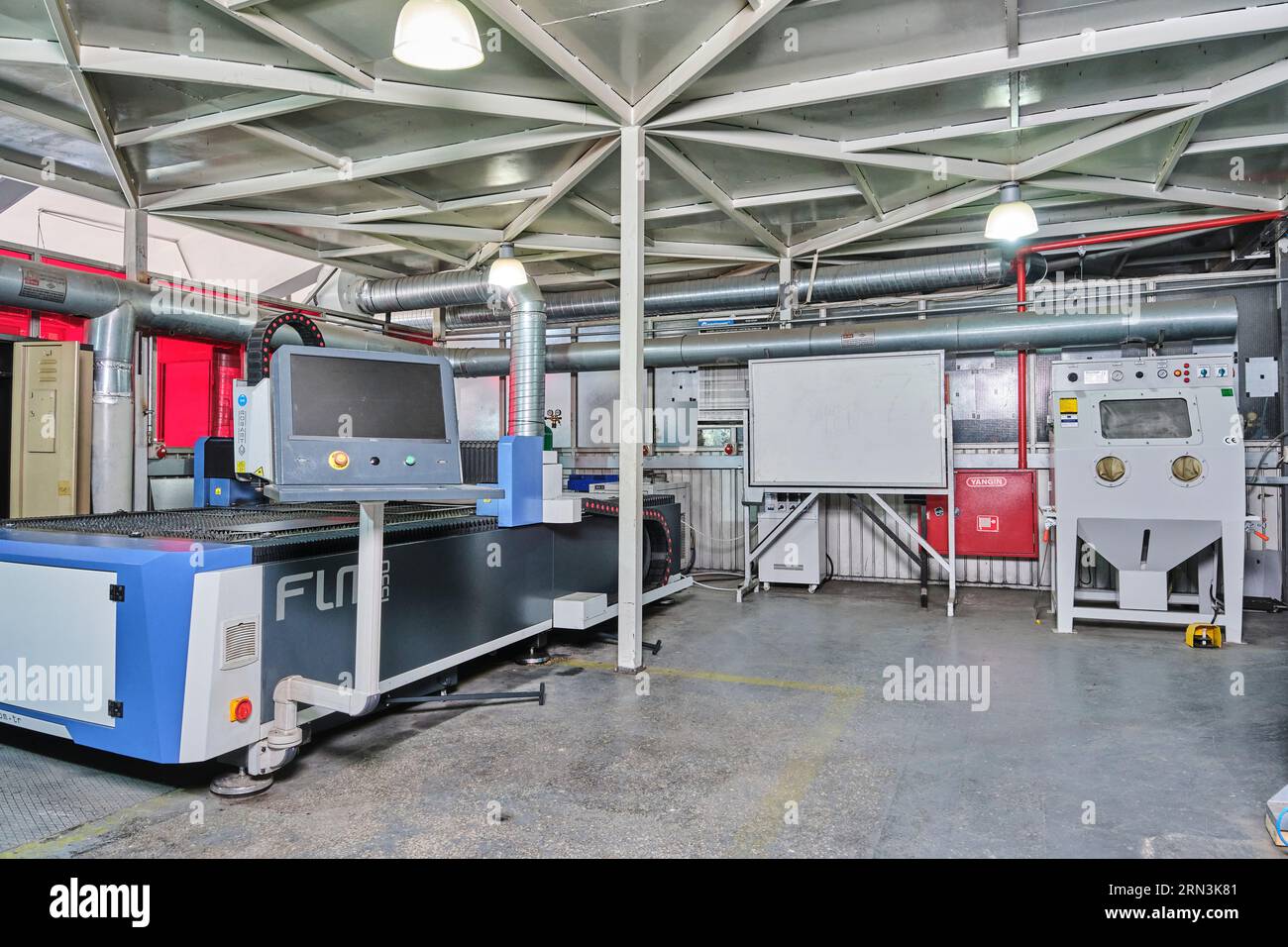 many identical industrial machinery in a row at a factory. equipment of ...