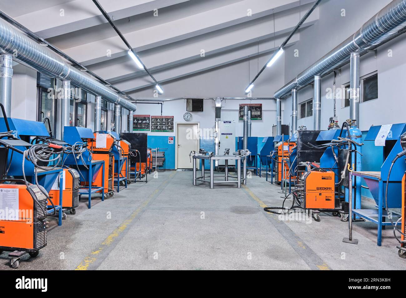 many identical industrial machinery in a row at a factory. equipment of ...