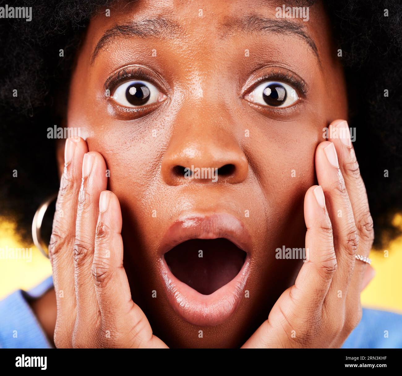 Scared, shock and surprised woman in studio for fear, mental health or ...