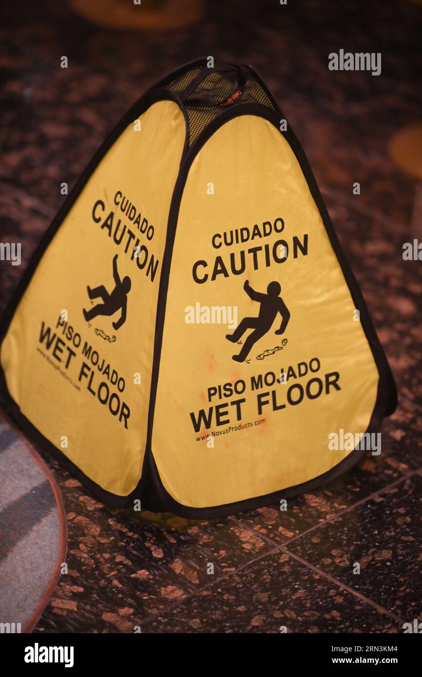 Sign showing warning of caution wet floor Stock Photo - Alamy