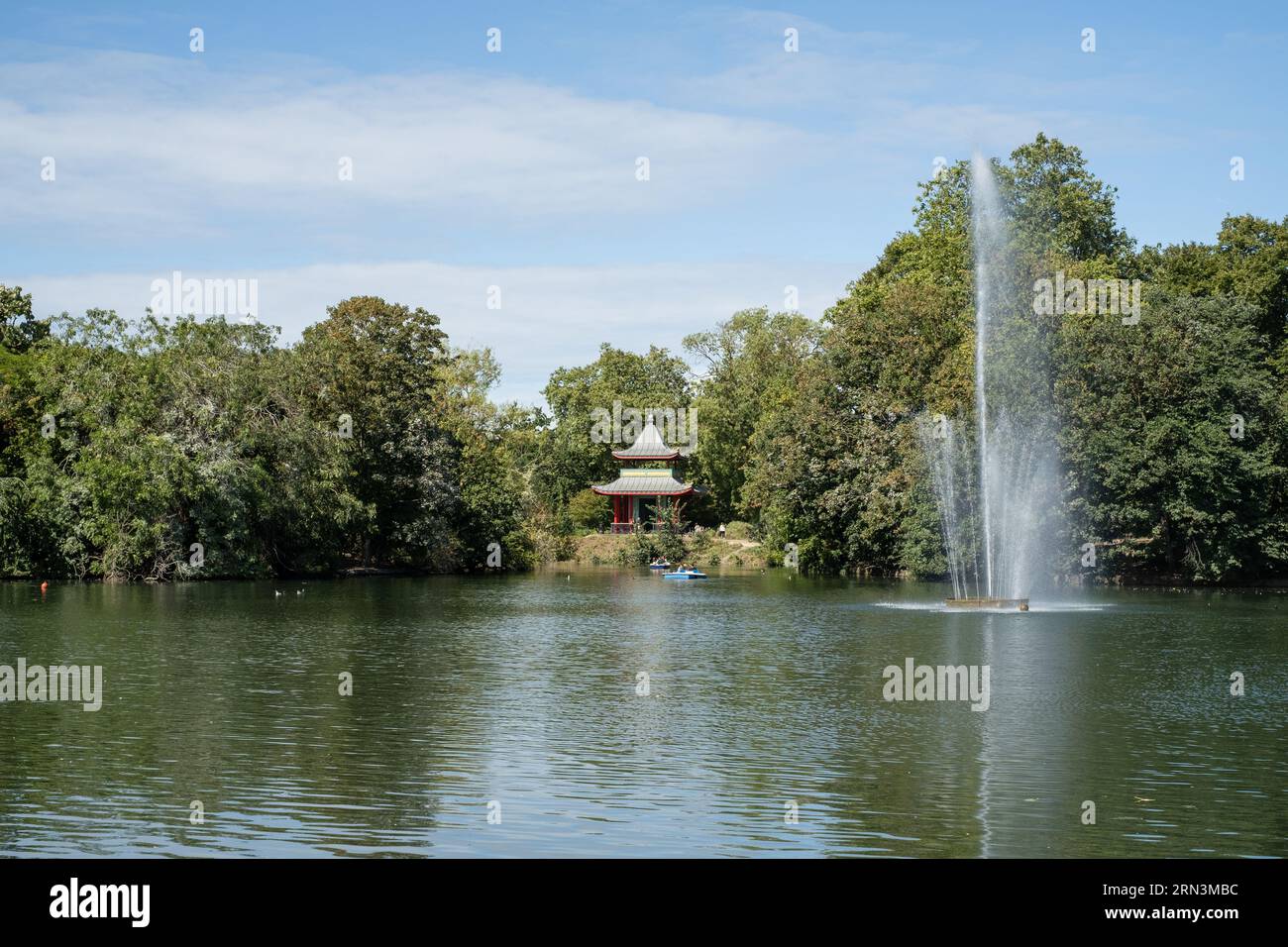 Chinese Pagoda, Victoria Park, London, with people in peddle and rowing ...