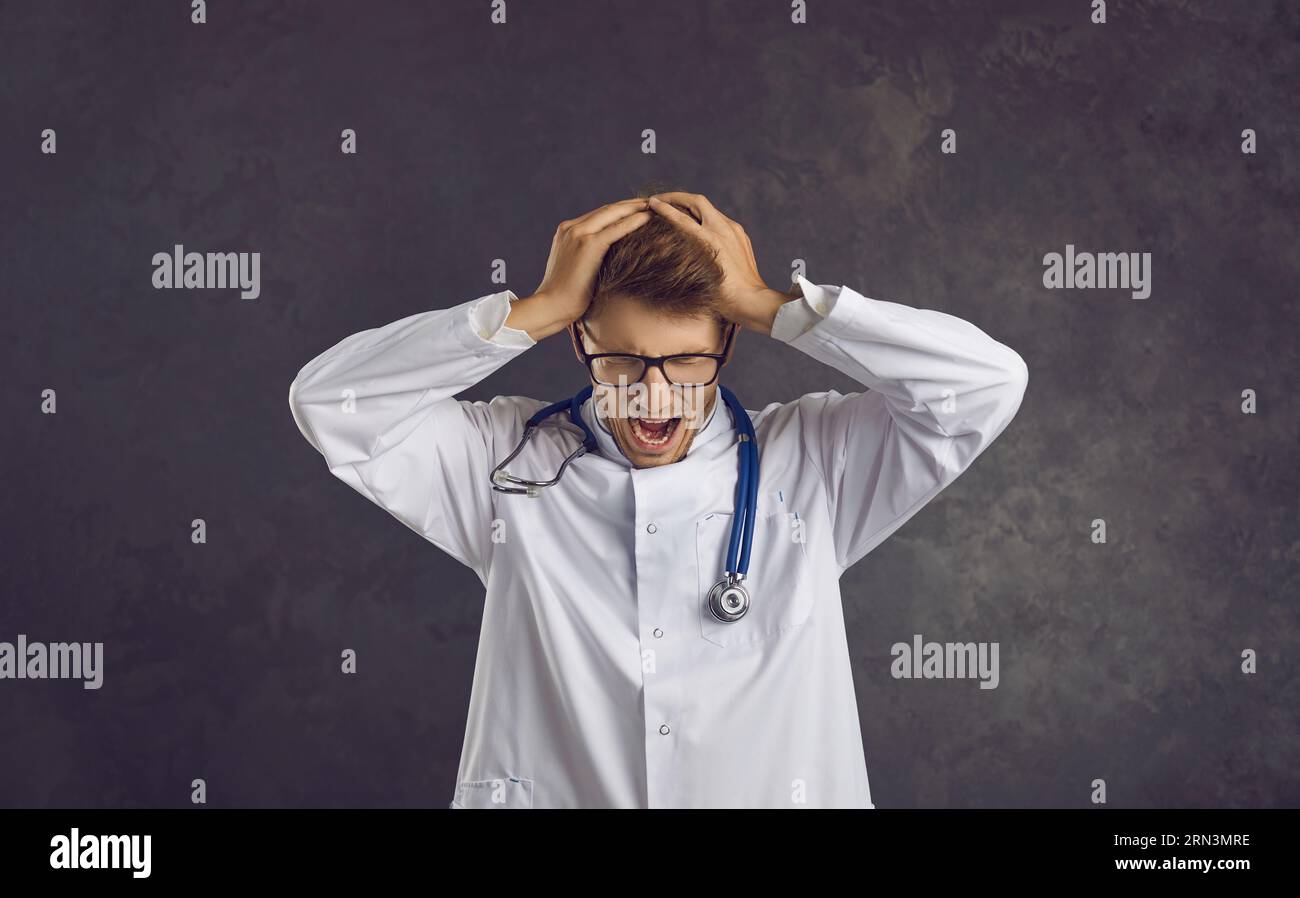 Overworked aggressive male health worker who screams madly from fatigue ...