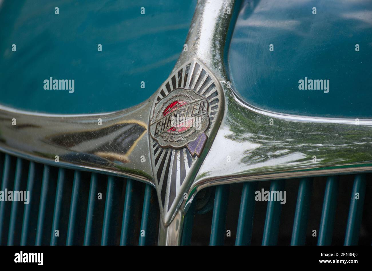 Closeup of a green/blue CHRYSLER oldtimer, showing the emblem with logo ...
