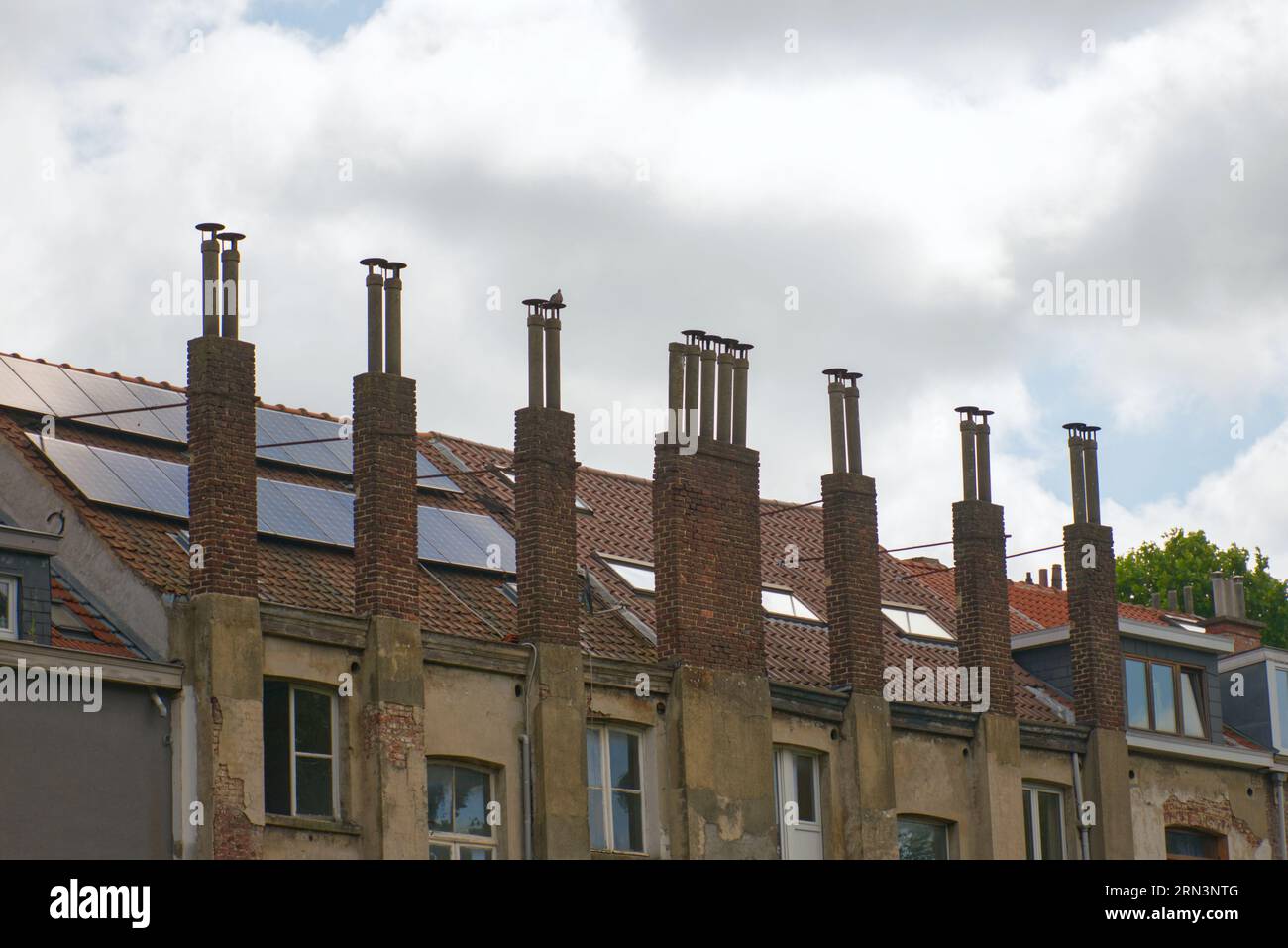 An old factory adapted as a residential building with big chimneys and ...