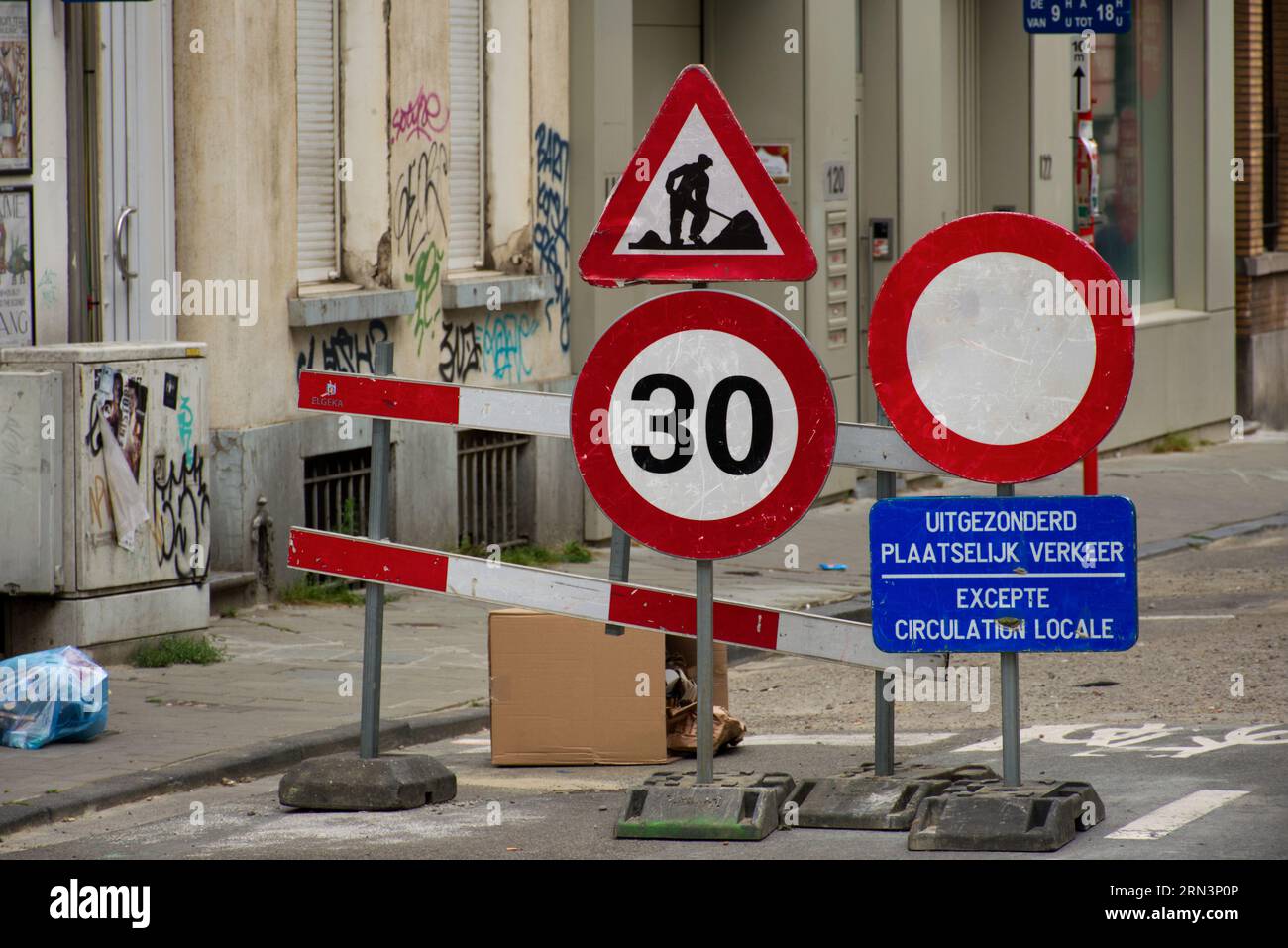 A roadblock with signs for safety preventing cars to enter the road ...