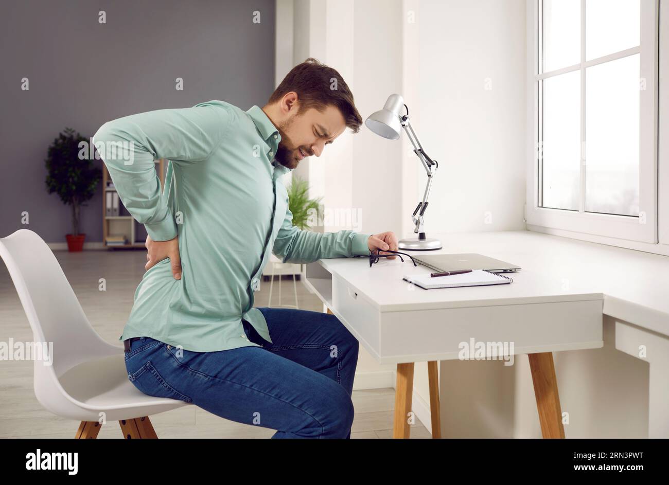 Tired young businessman back pain hi-res stock photography and images ...