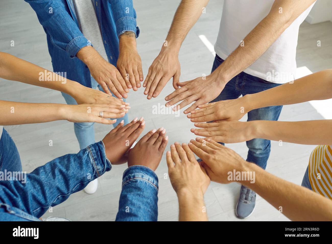 Team of people joining hands to show concept of teamwork, community ...