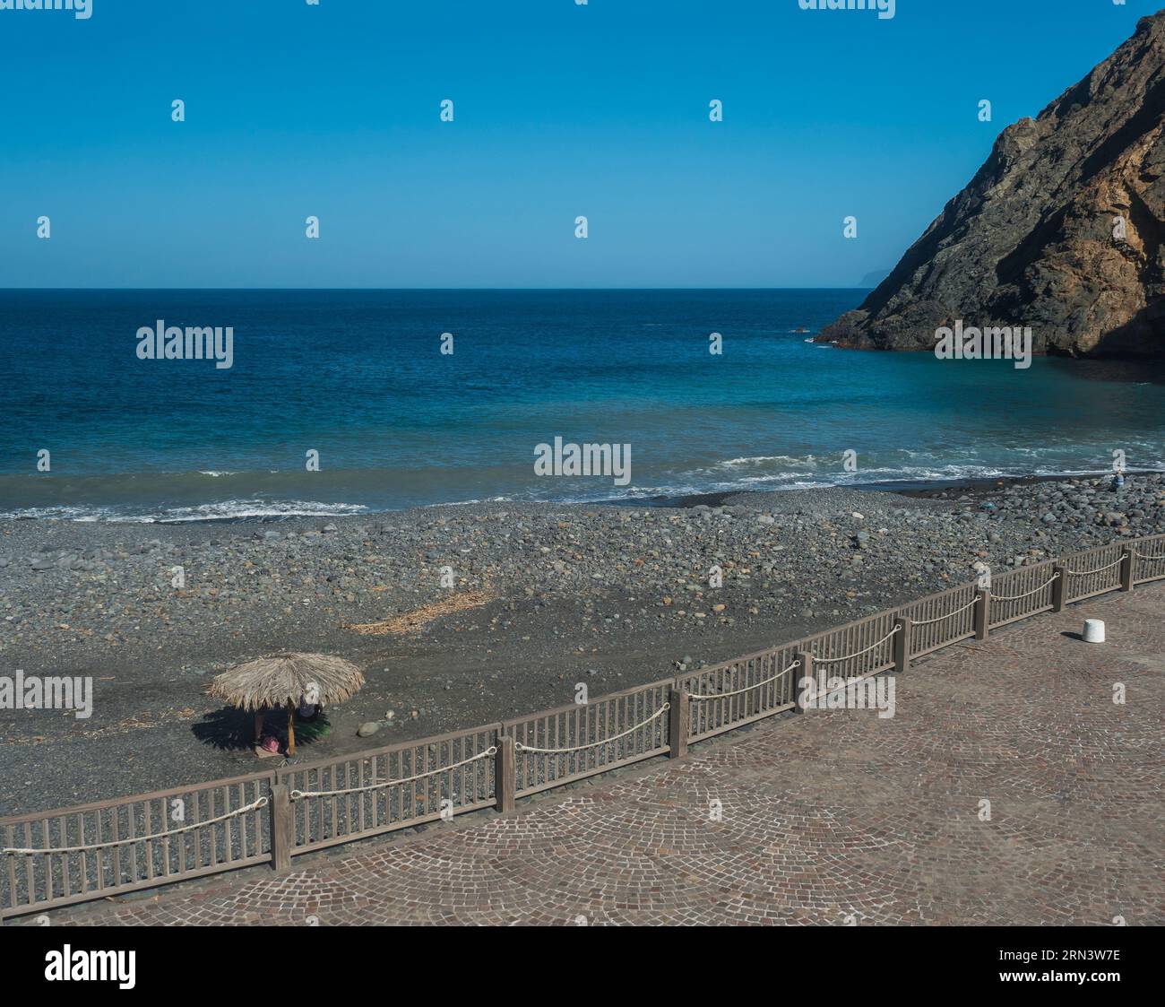 View of Playa de Vallehermoso, volcanic black sand beach with pebbles ...
