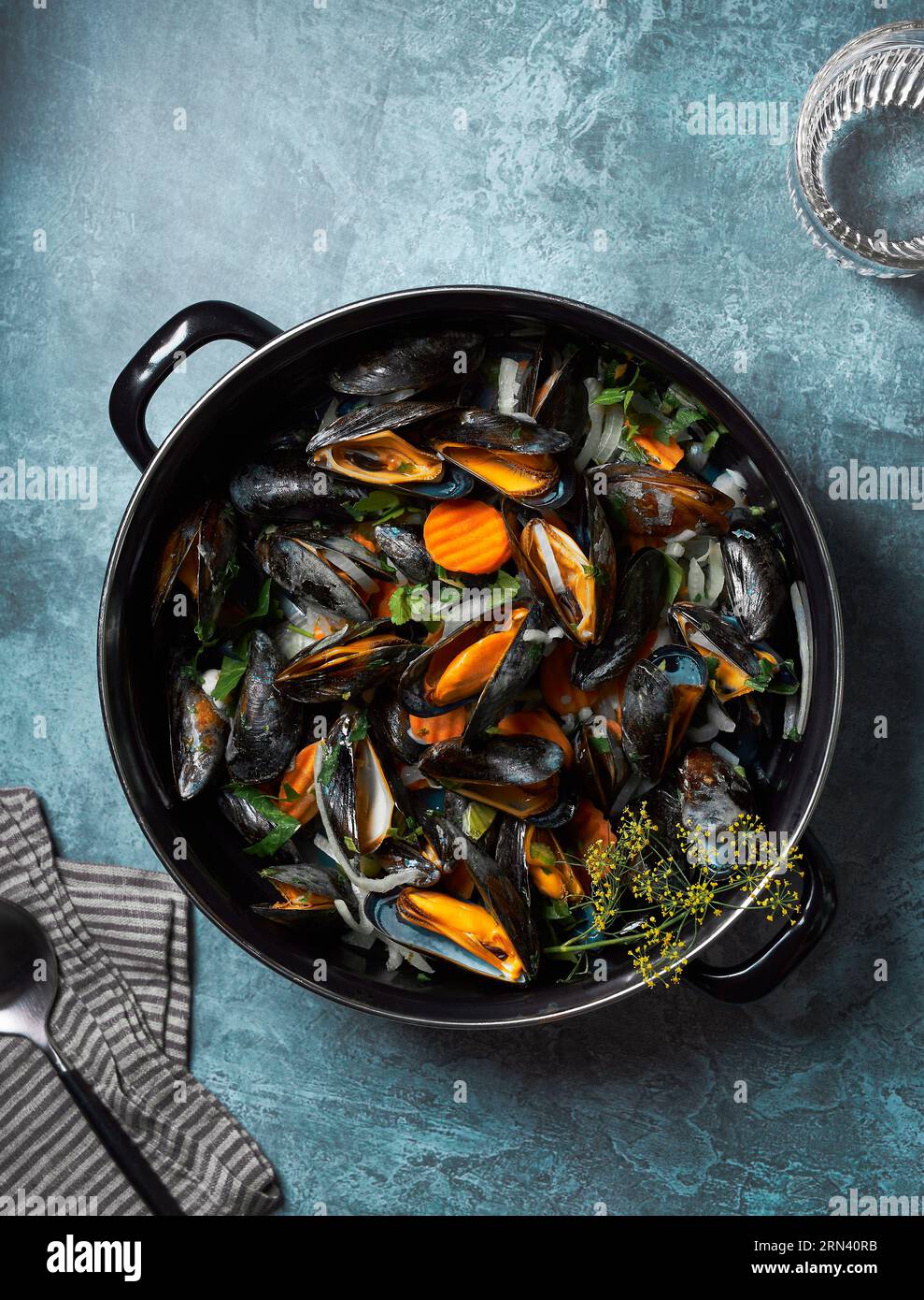 Top view flatlay image of steamed and ready to eat mussels in the black ...