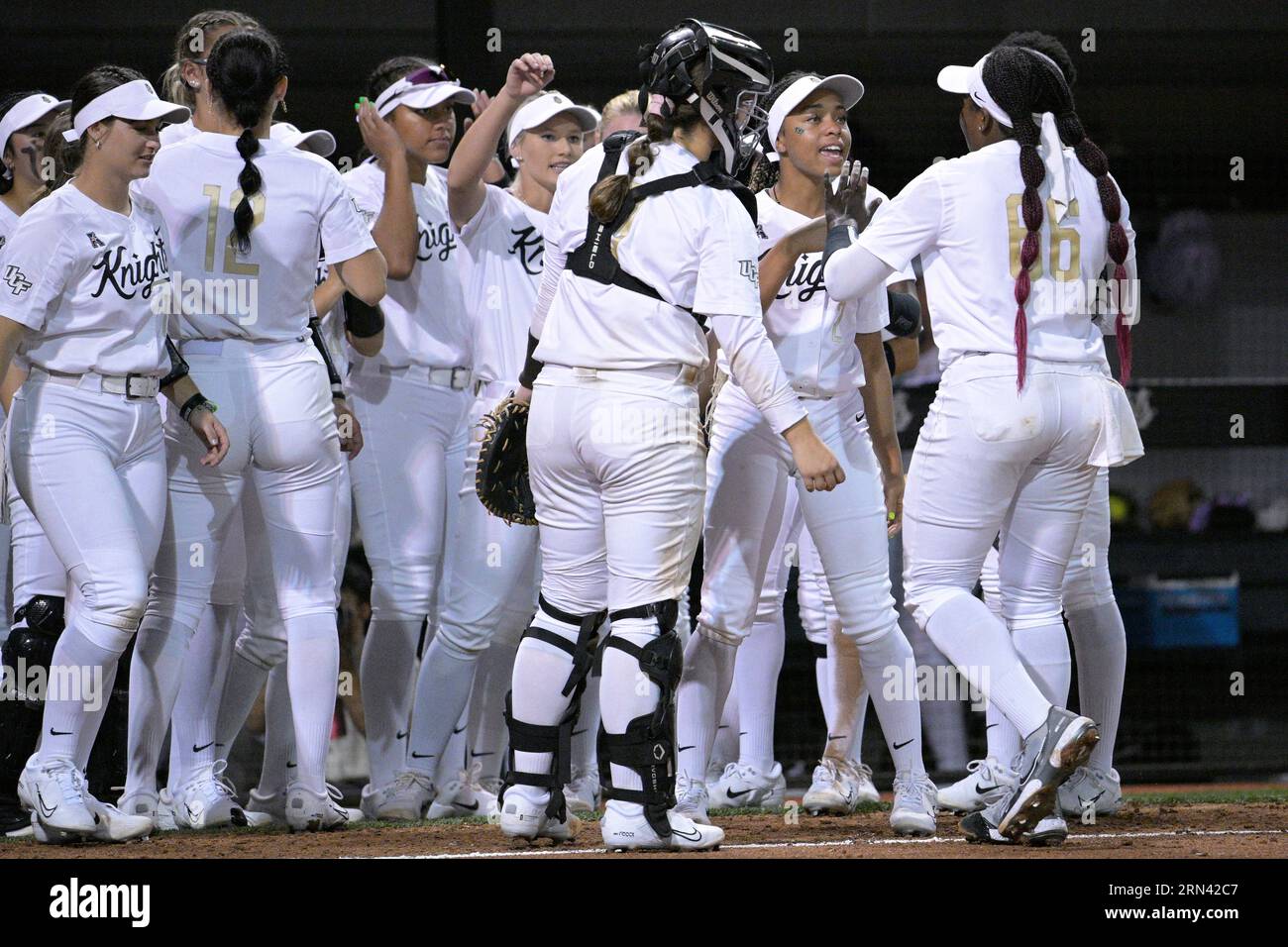 Central Florida pitcher Sarah Willis (66) is met by teammates after ...