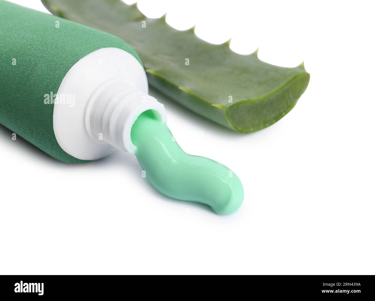 Open tube of toothpaste and aloe vera leaf on white background Stock ...