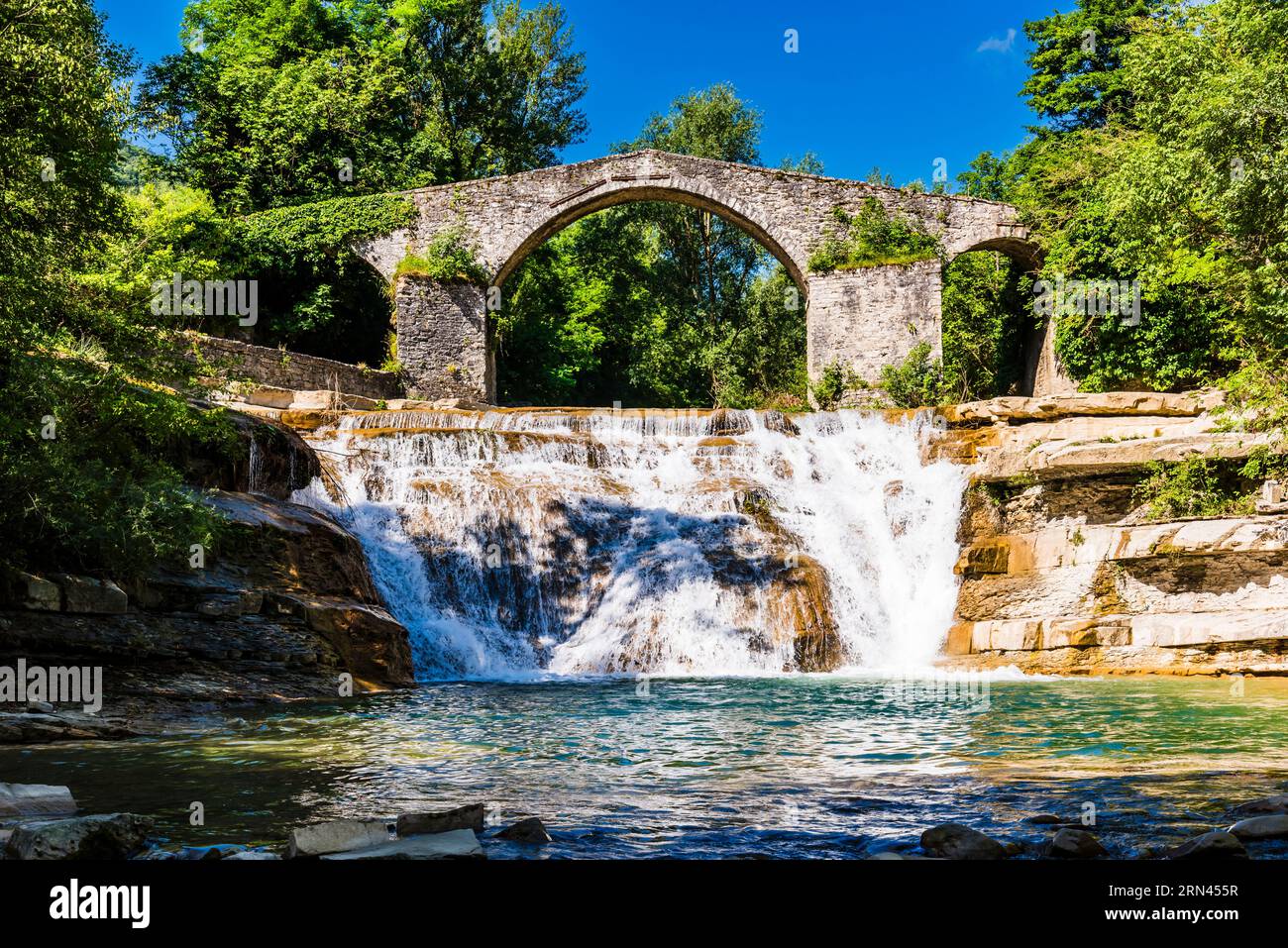 The medieval bridge Ponte della Brusia over the river Fiume Montone and ...
