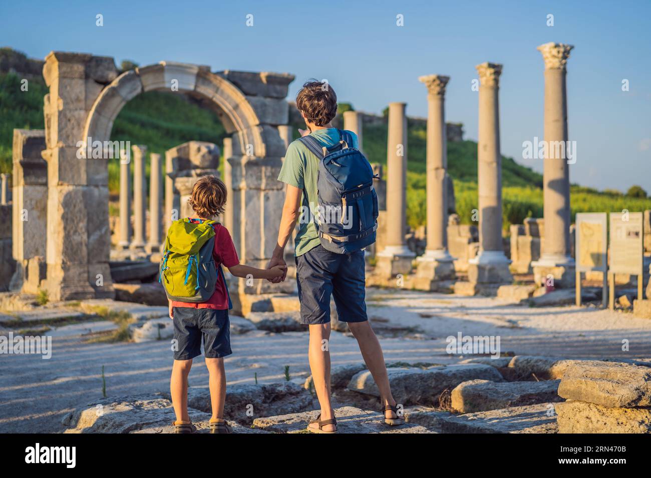 dad and son tourists at the ruins of ancient city of Perge near Antalya ...